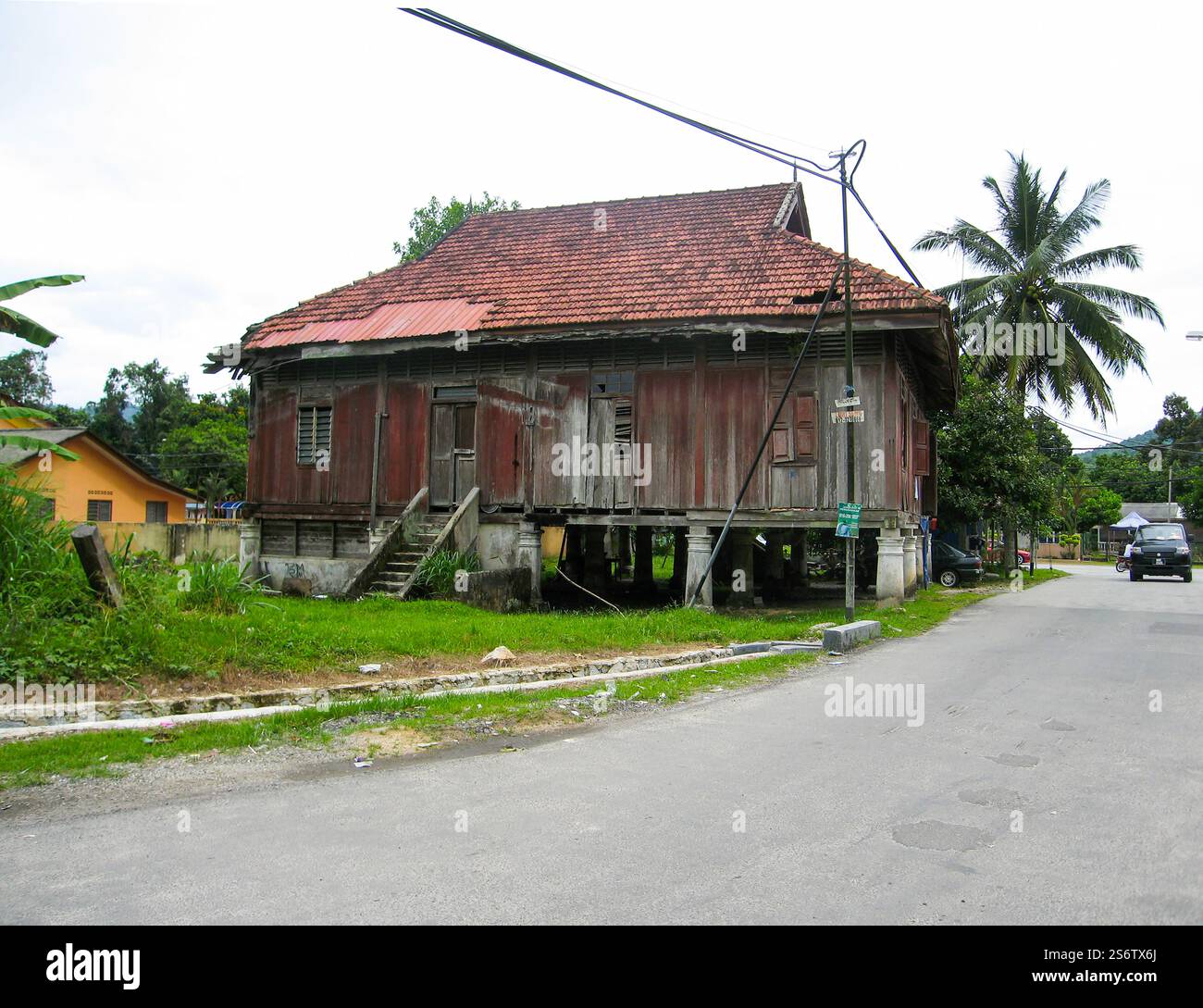 A typical traditional Malay wooden house on stilts in the village of ...