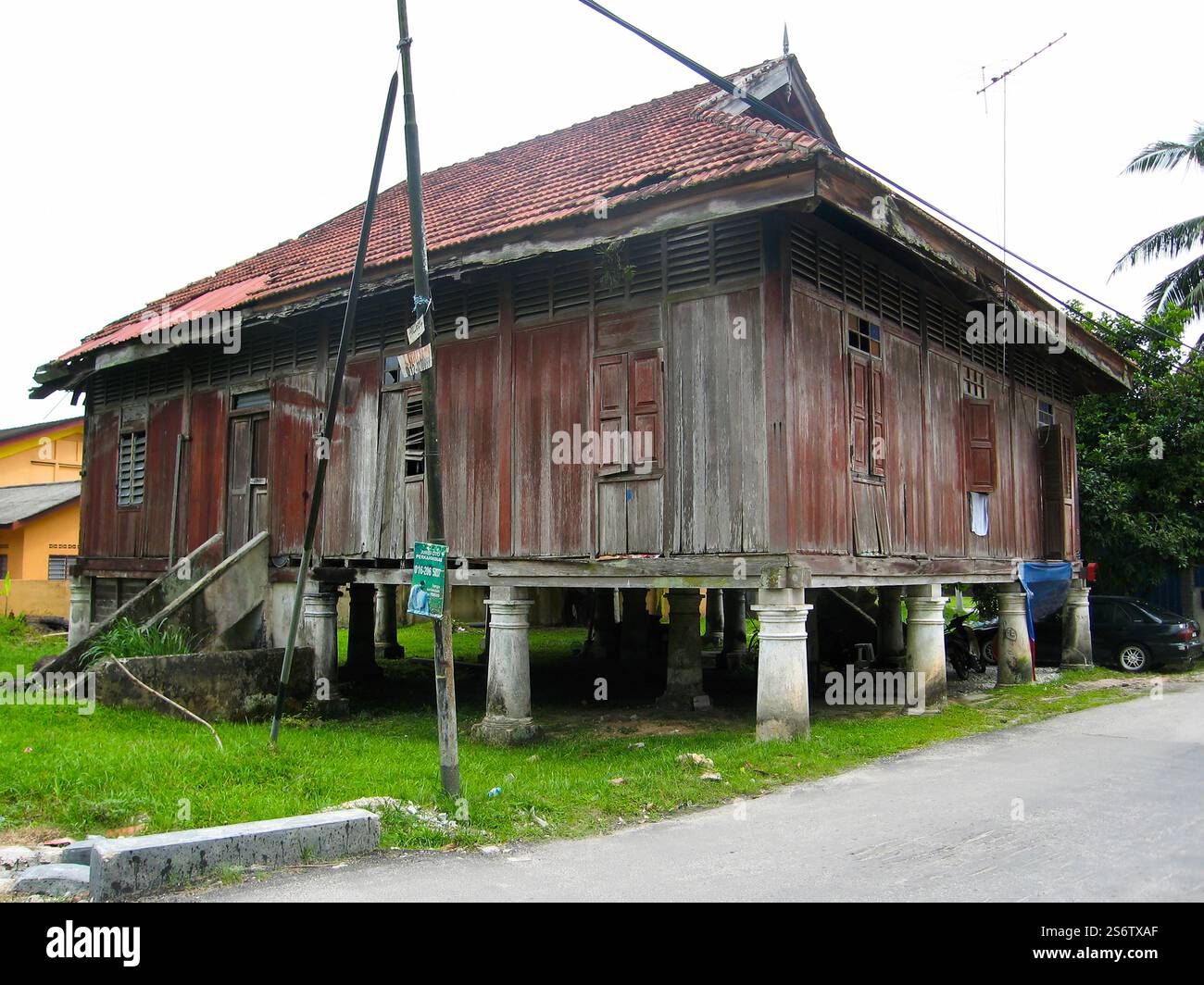 A typical traditional Malay wooden house on stilts in the village of ...
