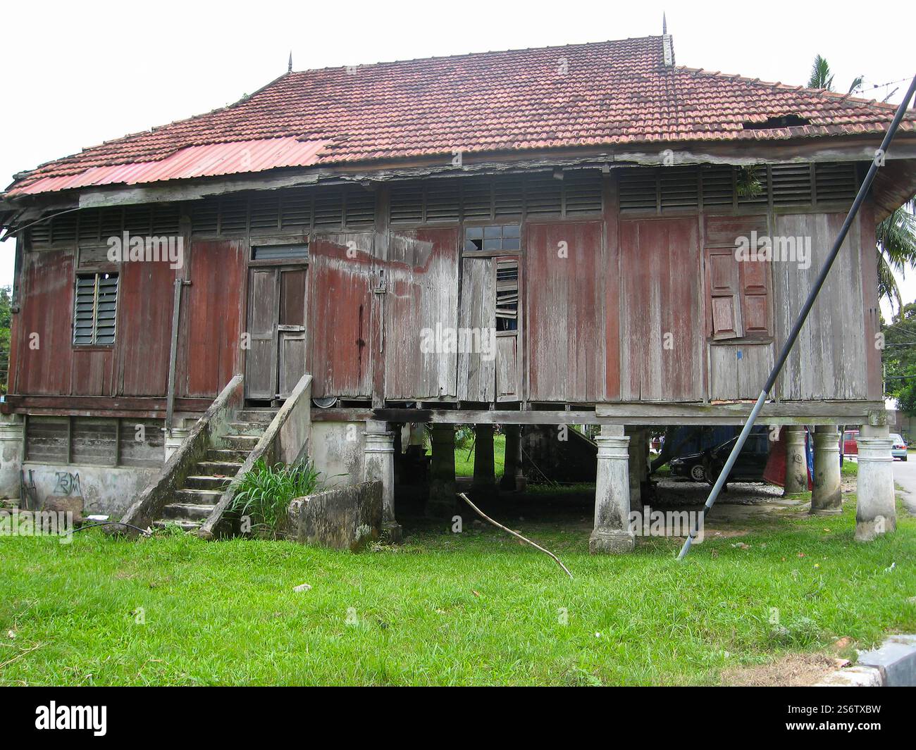 A typical traditional Malay wooden house on stilts in the village of ...