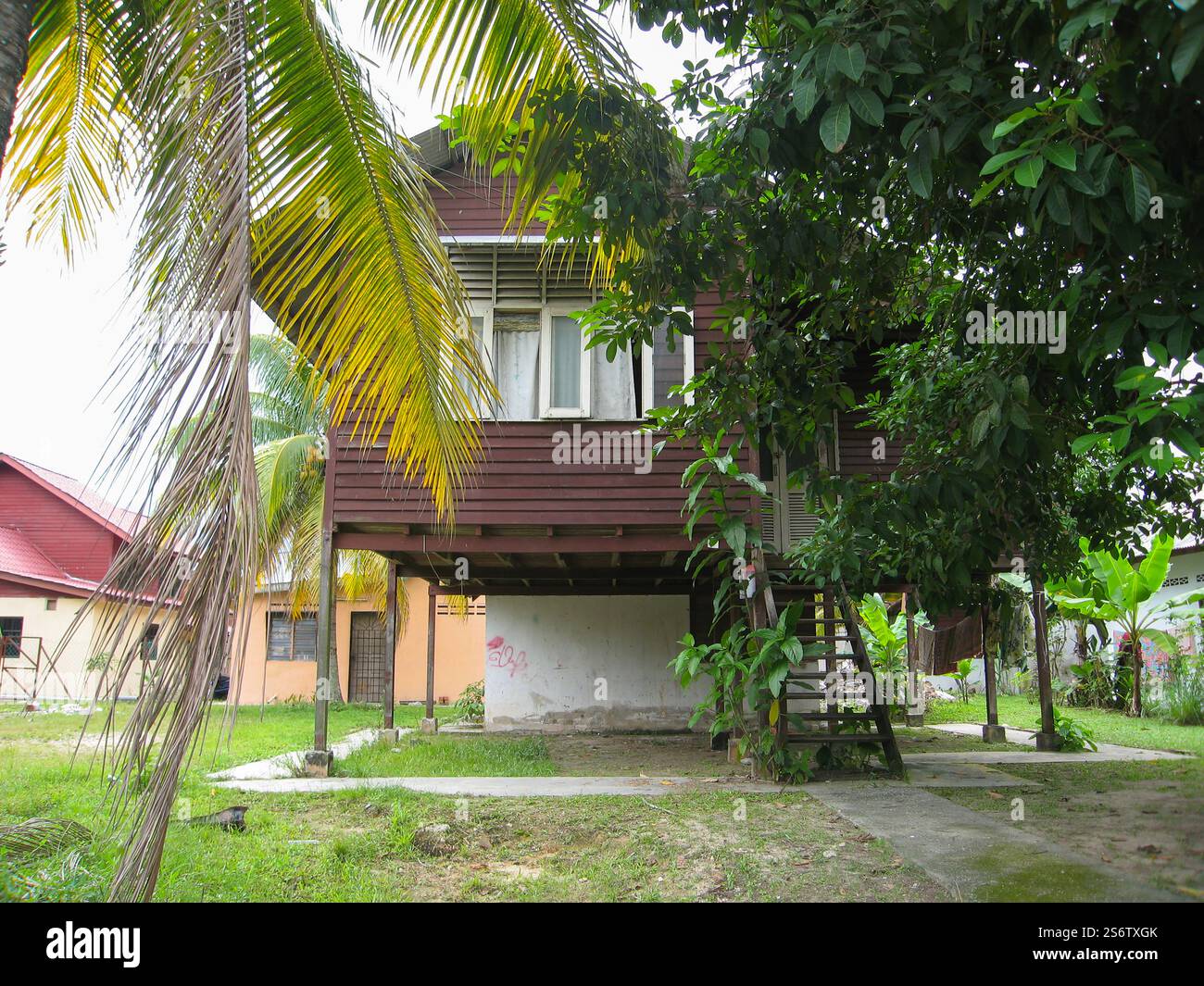 A typical traditional Malay wooden house on stilts in the village of ...