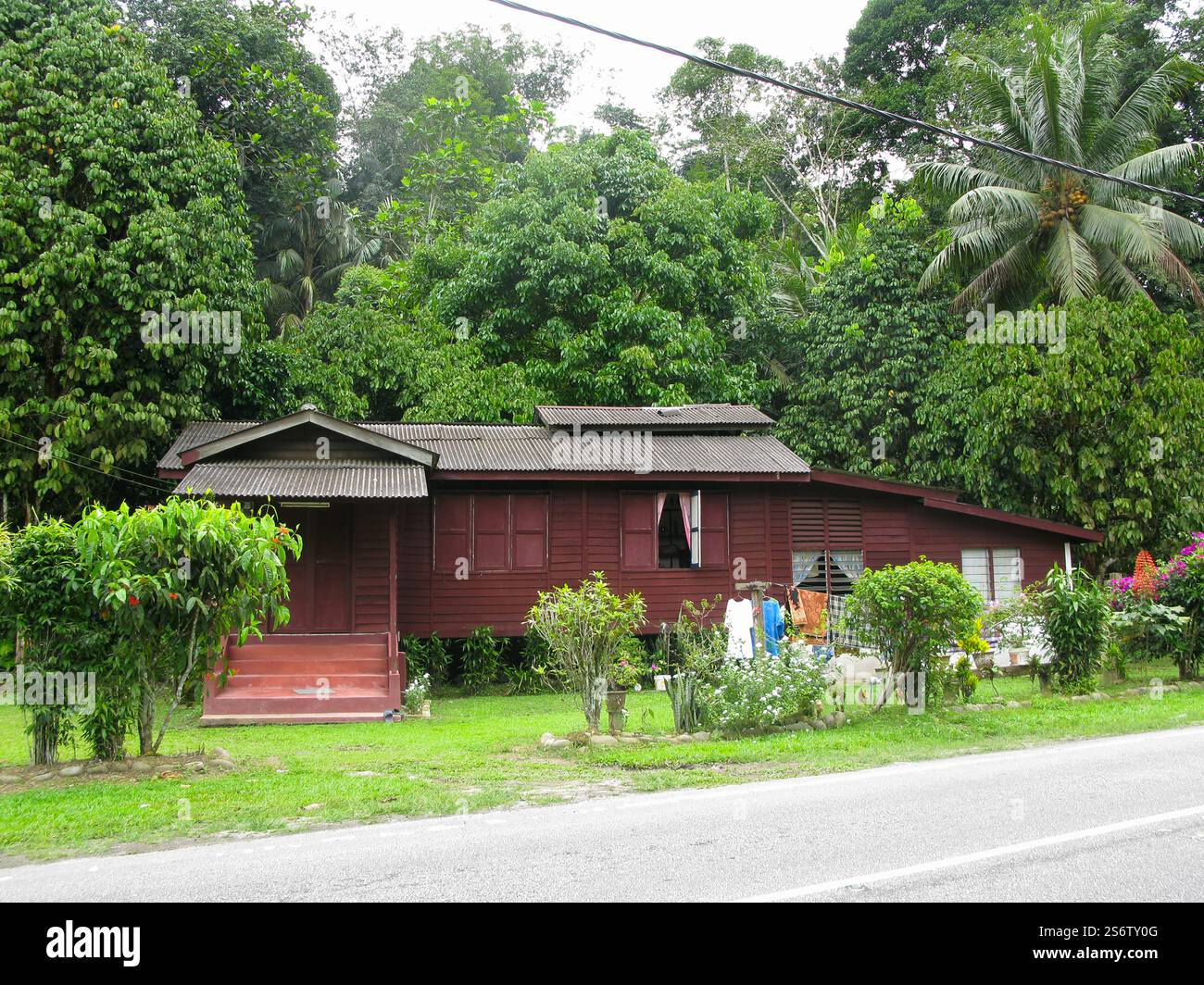 A typical traditional Malay wooden house on stilts in the village of ...