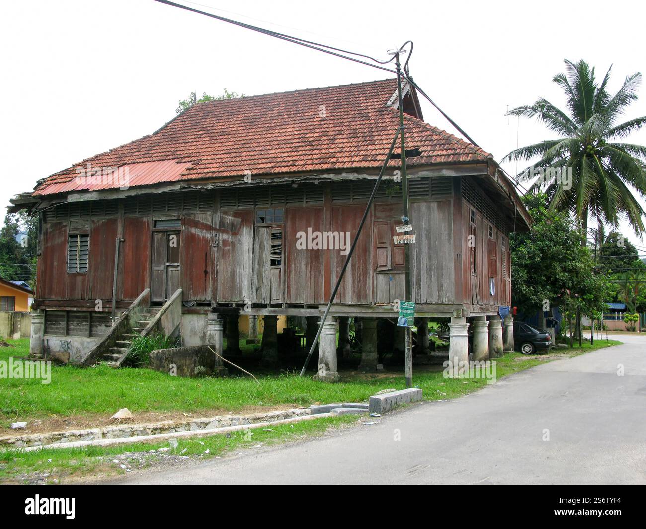 A typical traditional Malay wooden house on stilts in the village of ...
