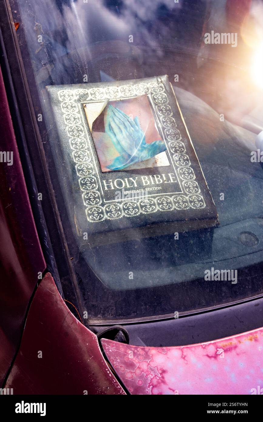 Bible on a car dashboard Stock Photo - Alamy