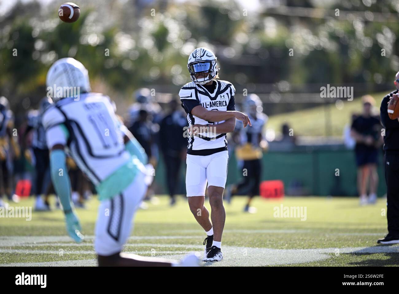 Team Unstoppable quarterback KJ Lacey (9) warms up before the Under ...