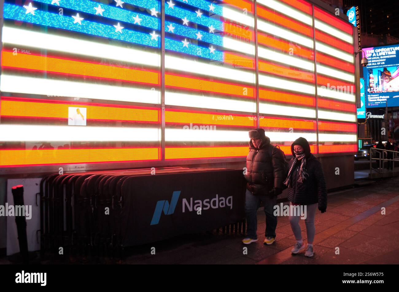 People walk past a lighting installation of the American flag in Times ...