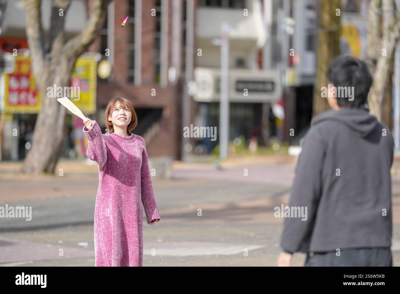 A Japanese man and woman in their 20s are playing hagoita, a ...