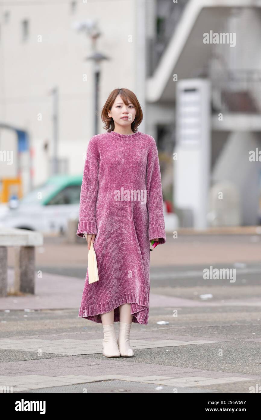 A Japanese man and woman in their 20s are playing hagoita, a ...