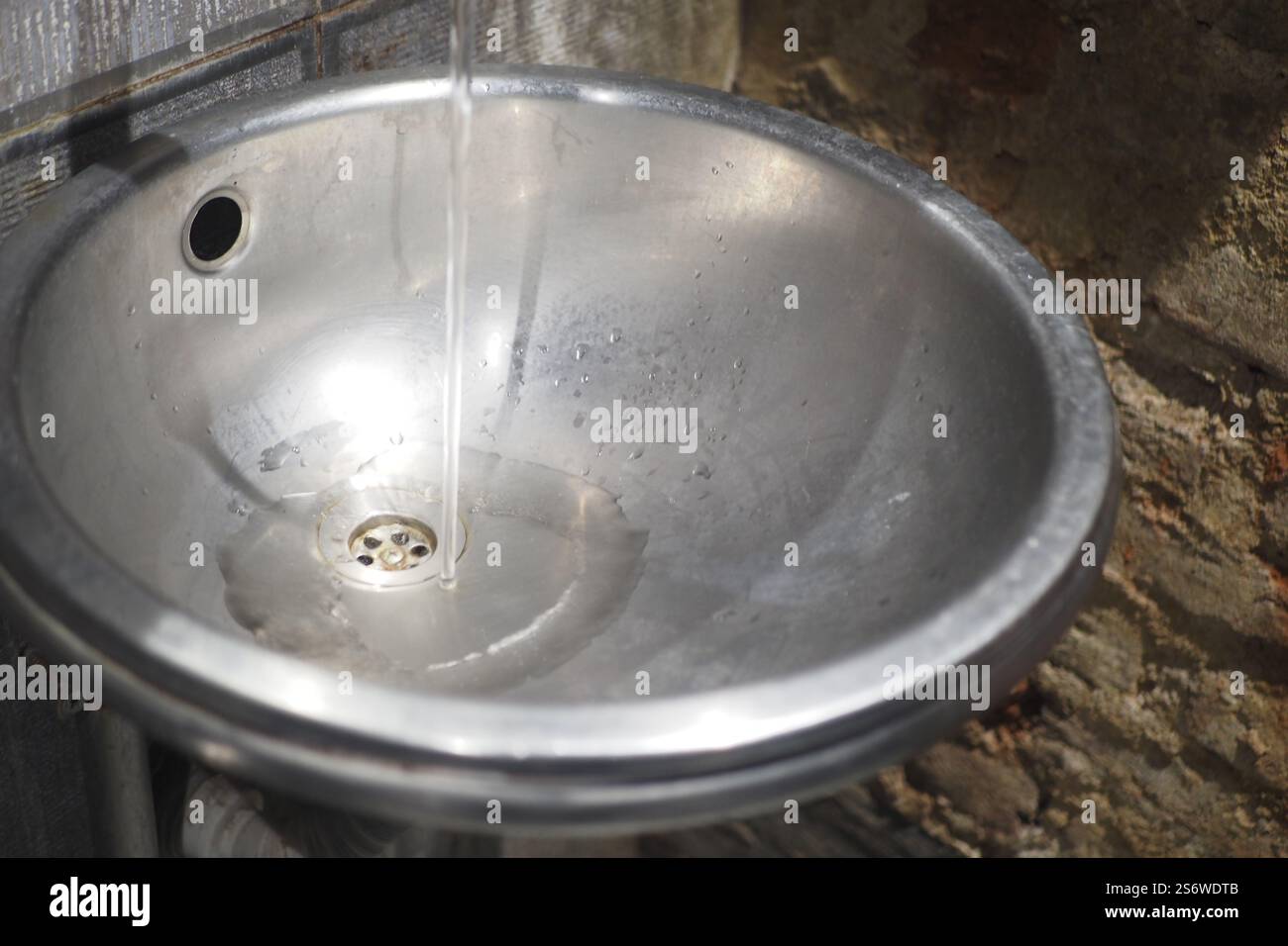 A Rustic Stainless Steel Sink with Running Water for modern homes Stock ...