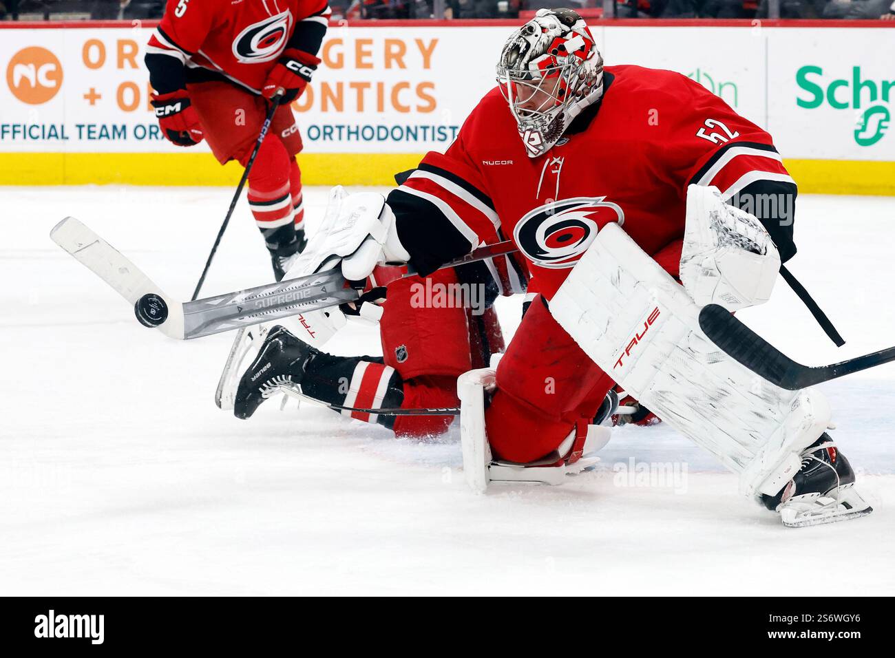 Carolina Hurricanes goaltender Pyotr Kochetkov (52) paddles the puck ...
