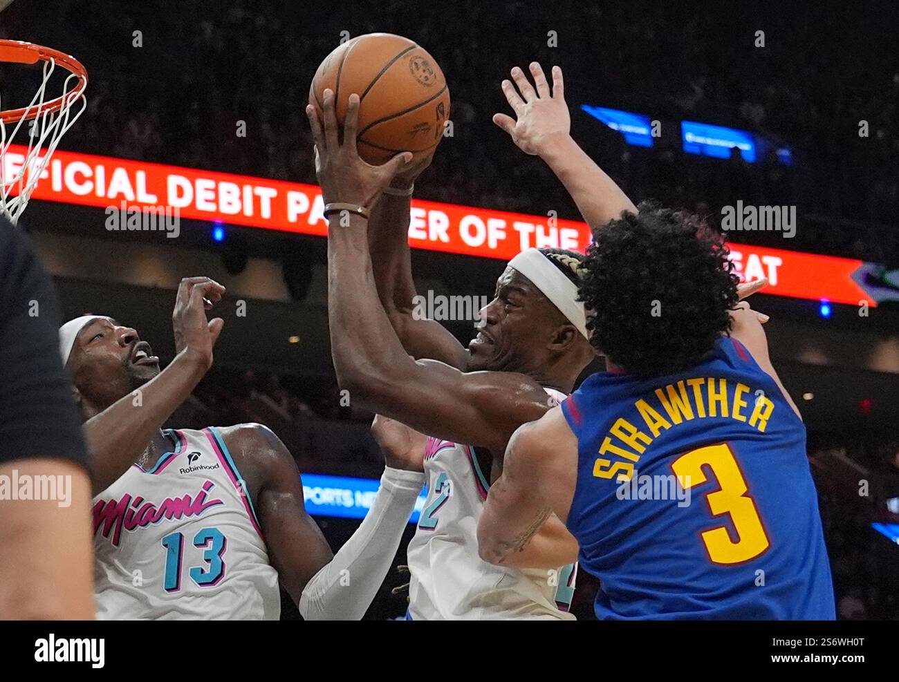Miami Heat center Bam Adebayo (13) and forward Jimmy Butler, center, go ...