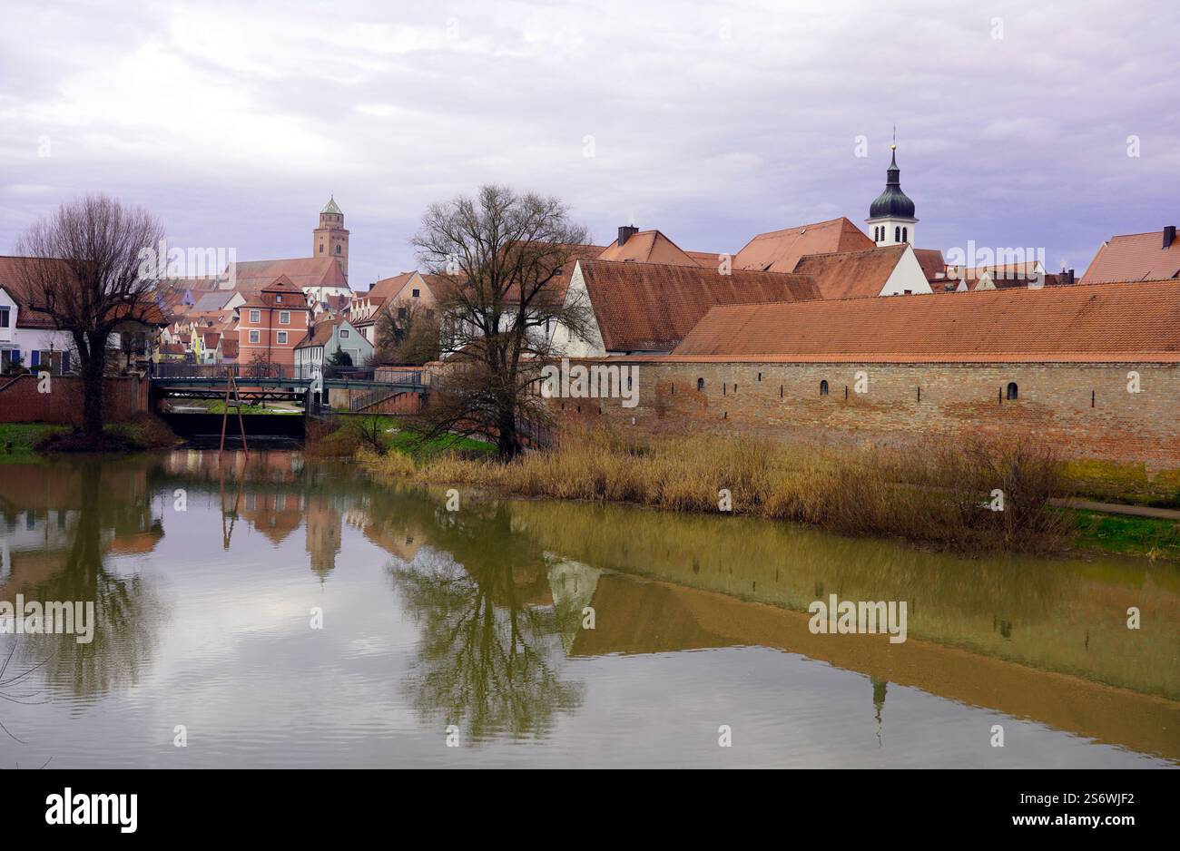 Danube River flowing under a small bridge with church spires and ...
