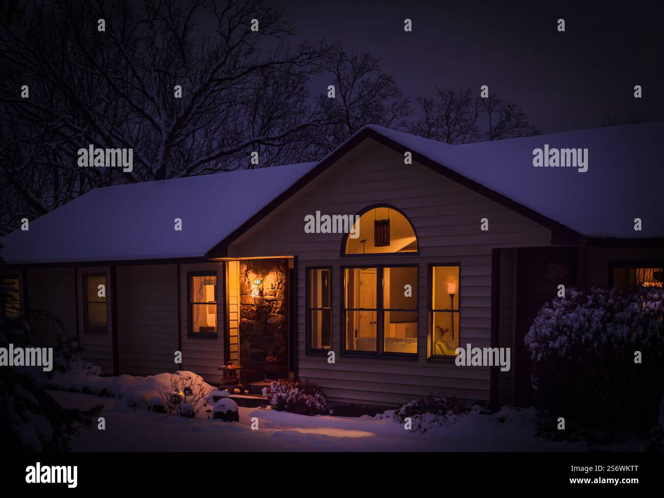 View of Midwestern suburban house with large windows after snowfall at ...