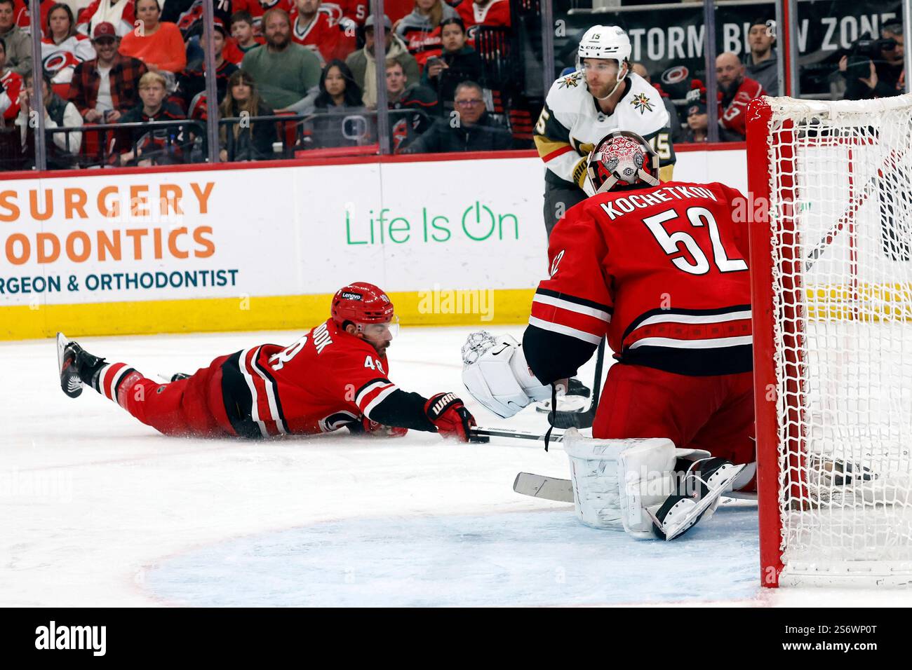 Carolina Hurricanes' Jordan Martinook (48) dives to the ice to snare ...