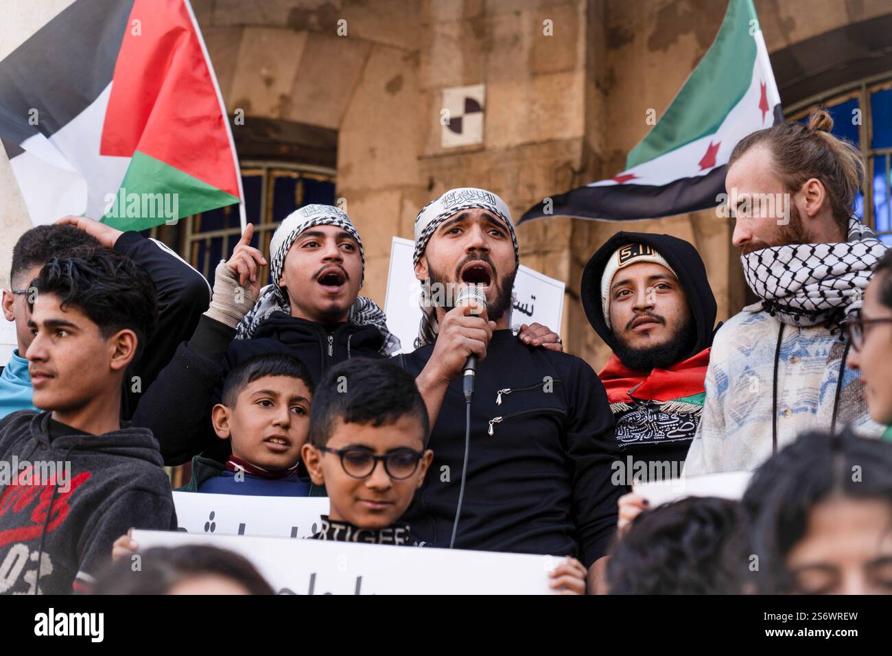 Damascus, Syria. 17th Jan, 2025. Two men are seen chanting to protest ...