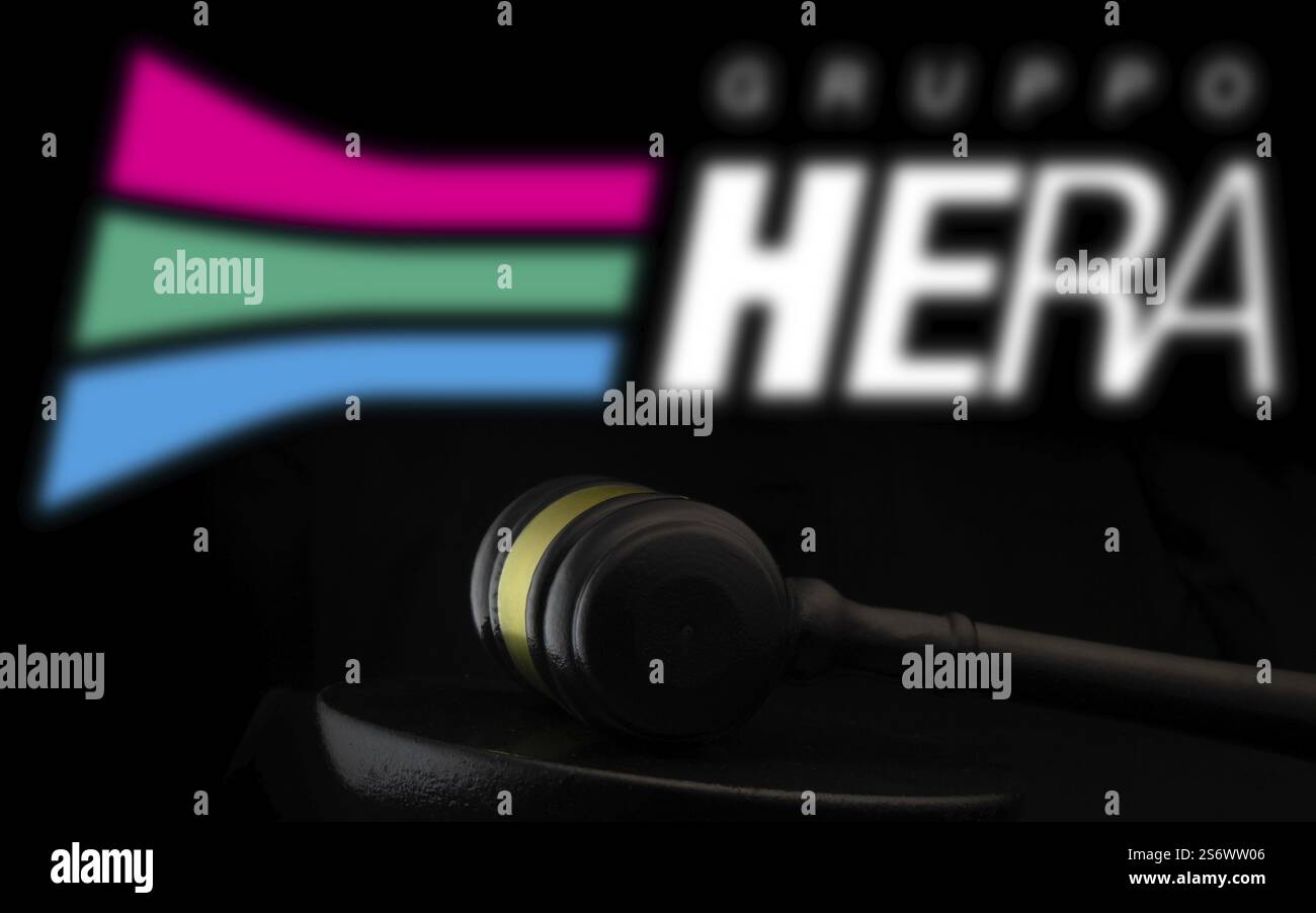 Court gavel in front of the Gruppo hera logo. Hera spa is a multiutility company Stock Photo - Alamy