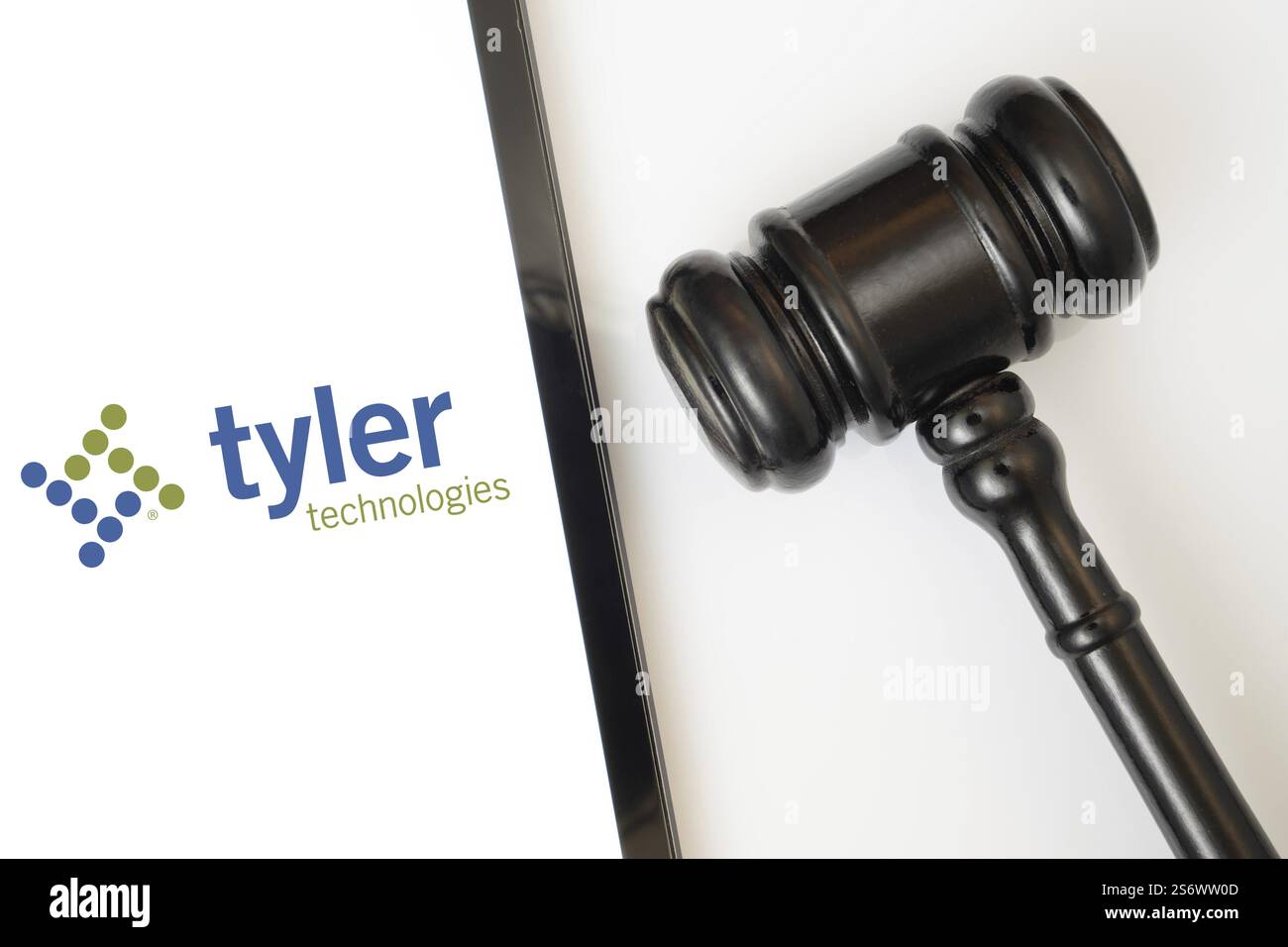 An iPad displays the tyler technologies logo alongside a judge's gavel ...
