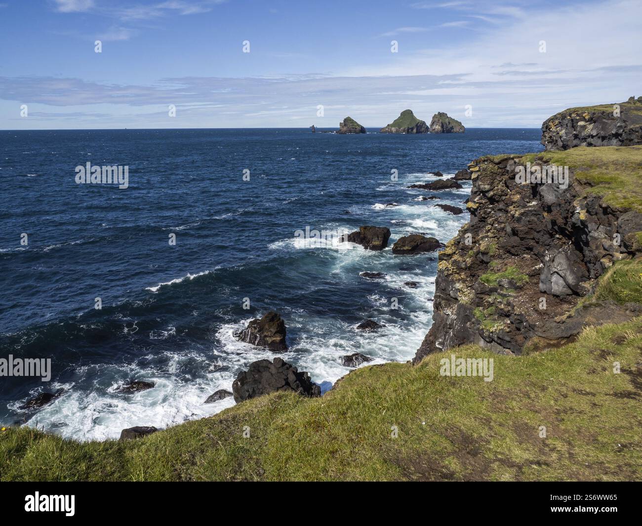 View from the island of Heimaey to the Vestmannaeyjar rock formation ...