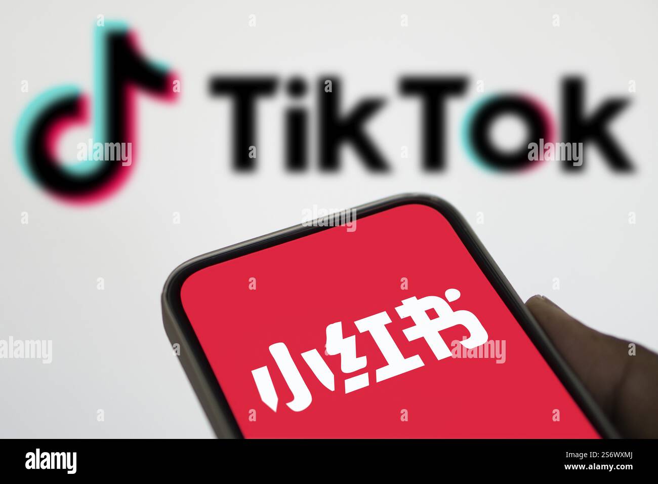 Xiaohongshu (REDnote) logo is displayed on smartphone and tiktok logo ...