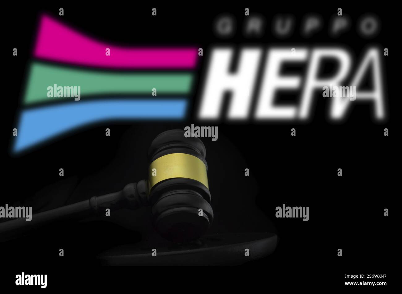 Court gavel in front of the Gruppo hera logo. Hera spa is a ...