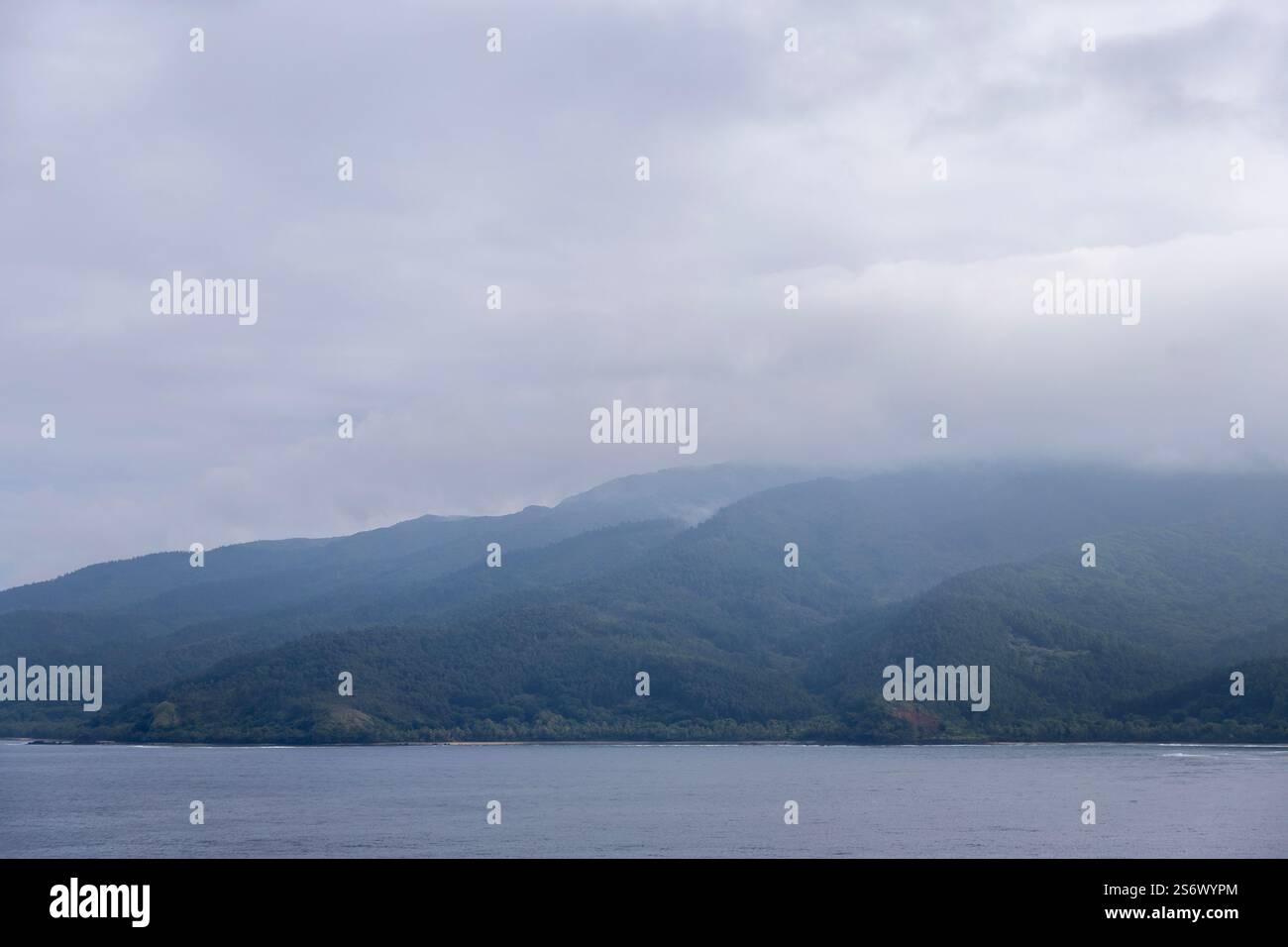 View of Aneityum Island on a cloudy and foggy day seen from the beach ...