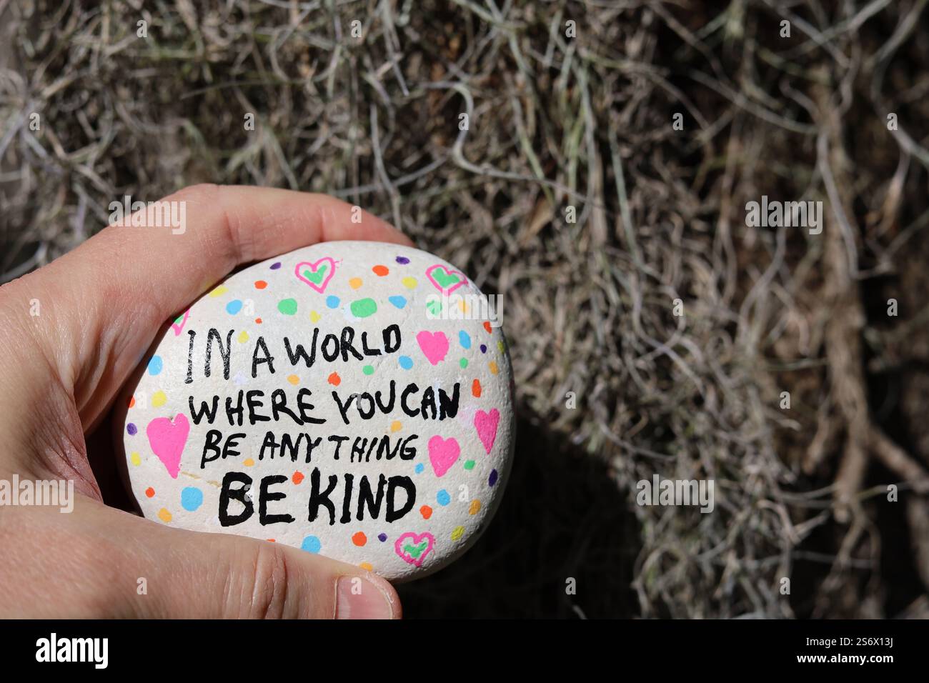 Be kind message painted onto kindness rock Stock Photo - Alamy