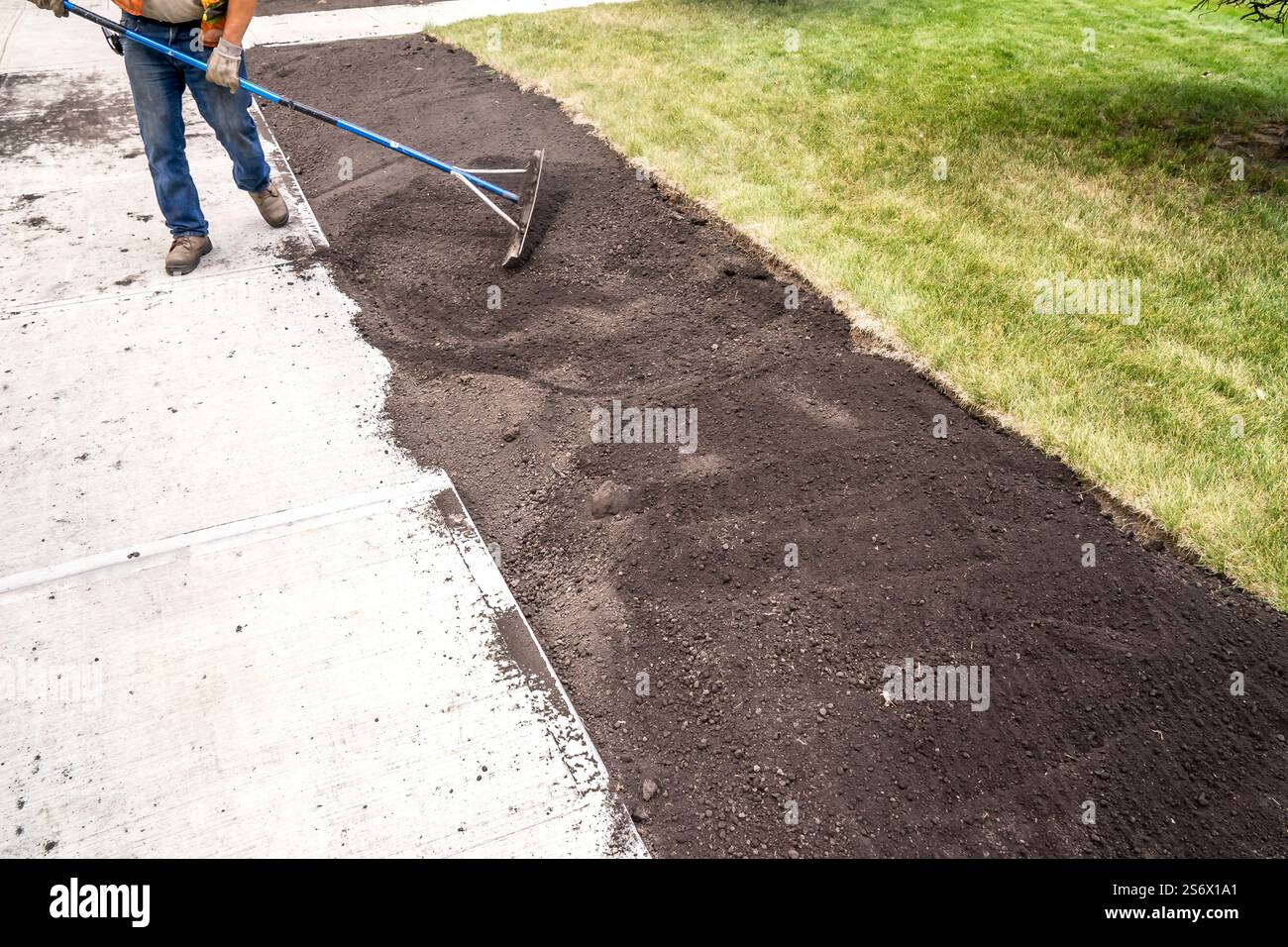 Landscaping work with top soil at sidewalk construction site Stock ...