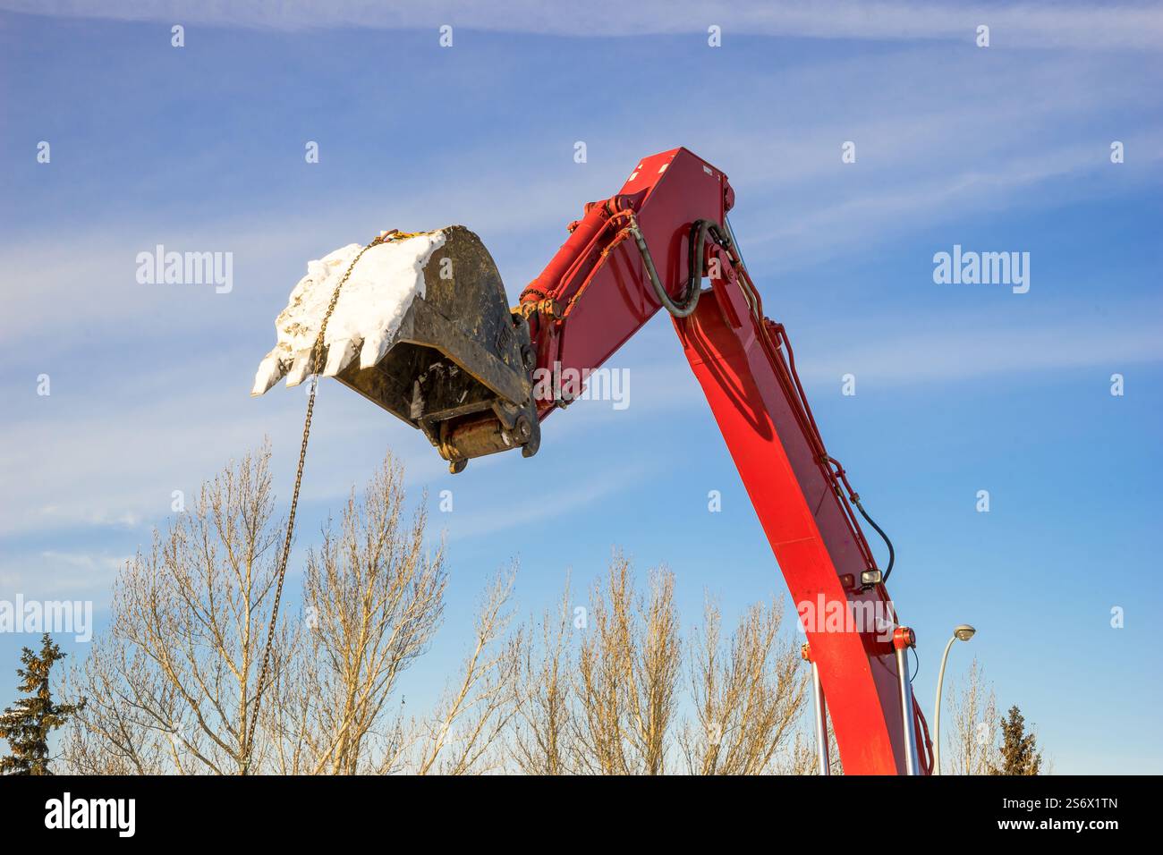 Excavatar is sued as crane with chain Stock Photo - Alamy