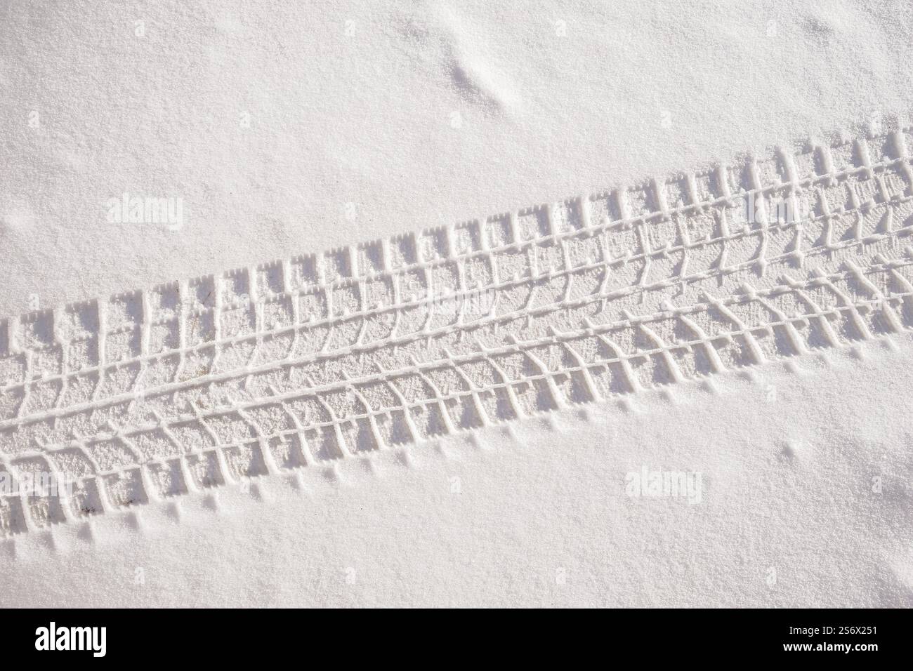 Car track in fresh snow Stock Photo - Alamy