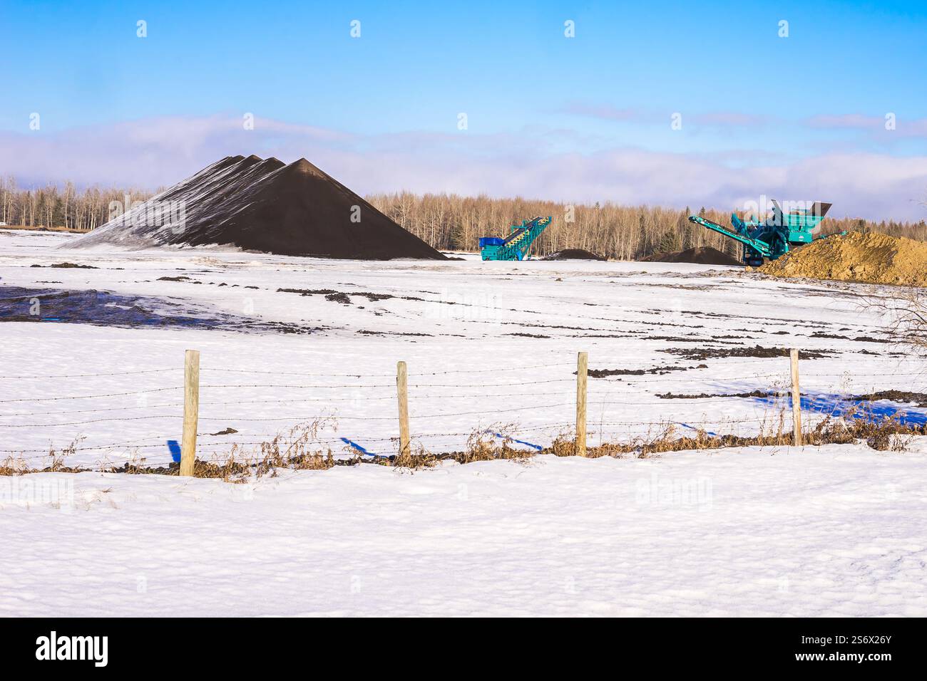 Top soil processing site in winter Stock Photo - Alamy