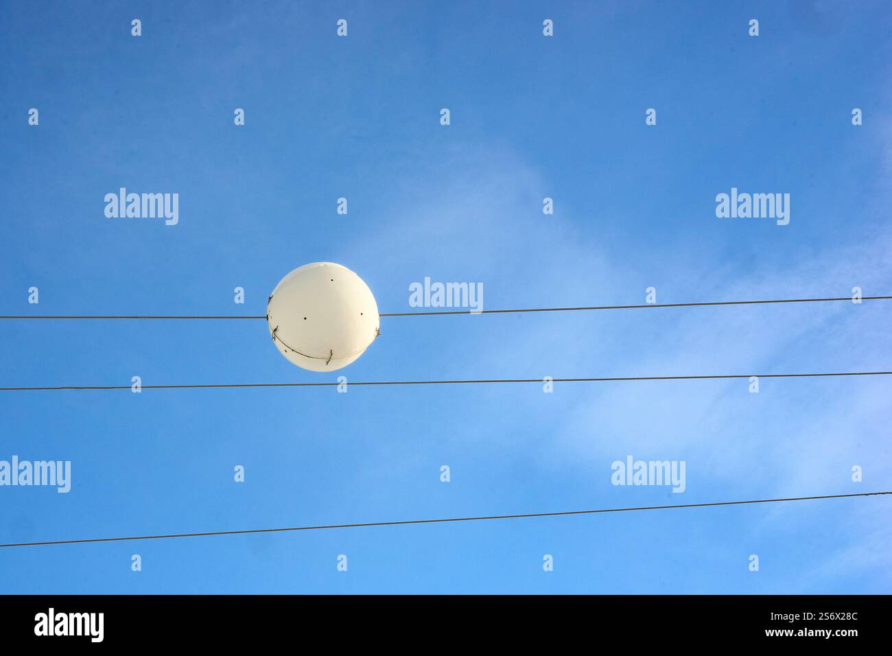 Power line white safety marking ball with icicle Stock Photo - Alamy