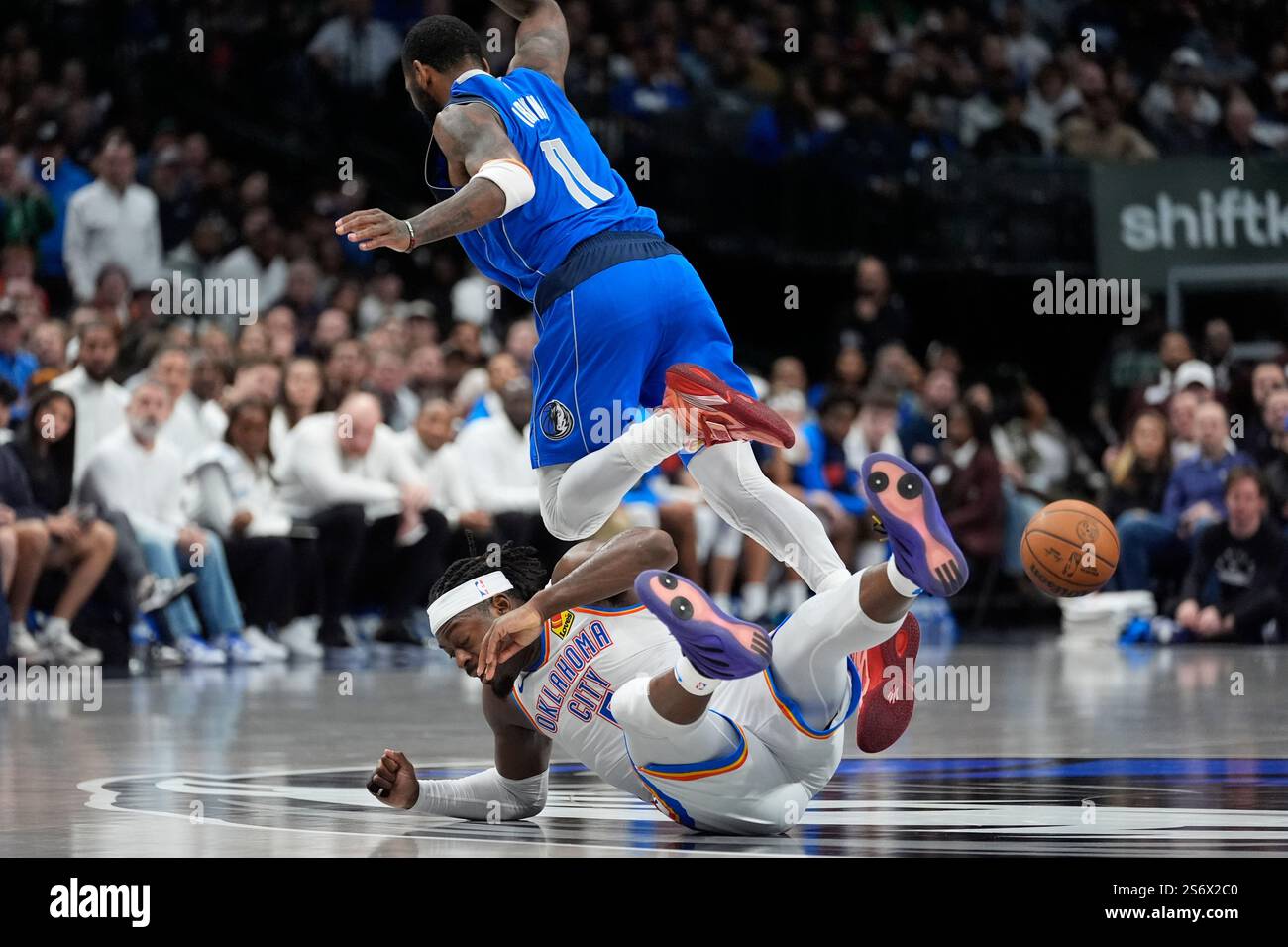 The ball goes loose after Dallas Mavericks guard Kyrie Irving (11) and ...