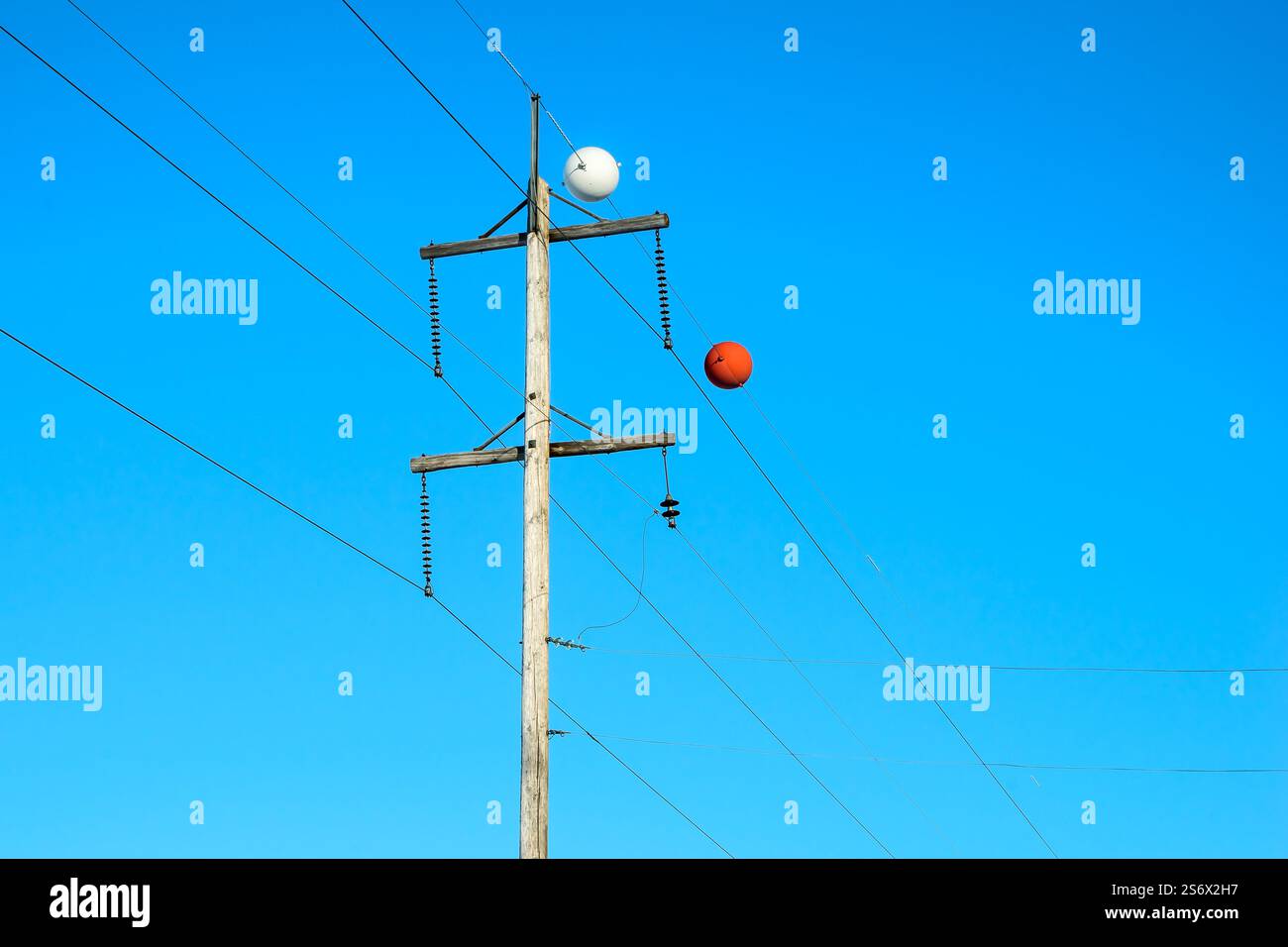 Power pole and safety ball markers with blue sky background Stock Photo ...
