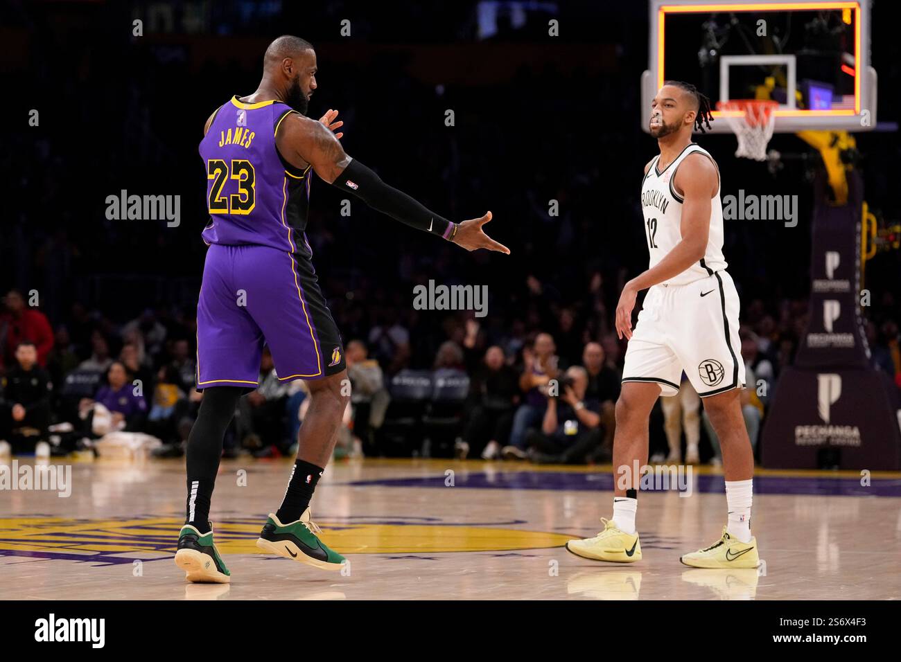 Los Angeles Lakers forward LeBron James, left, gestures toward fans ...