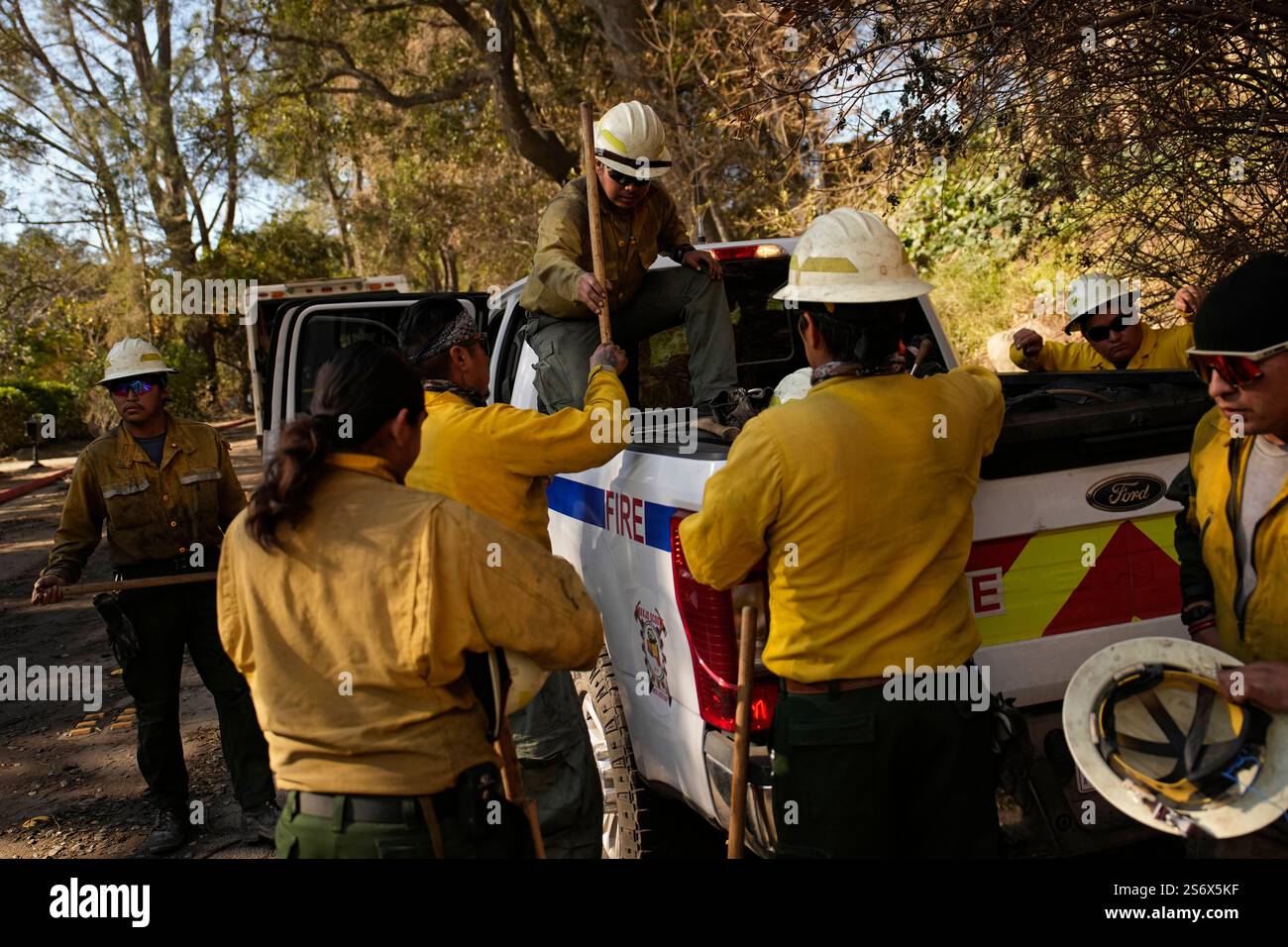 Firefighters from the Navajo Scouts firefighter crew unload hand tools ...