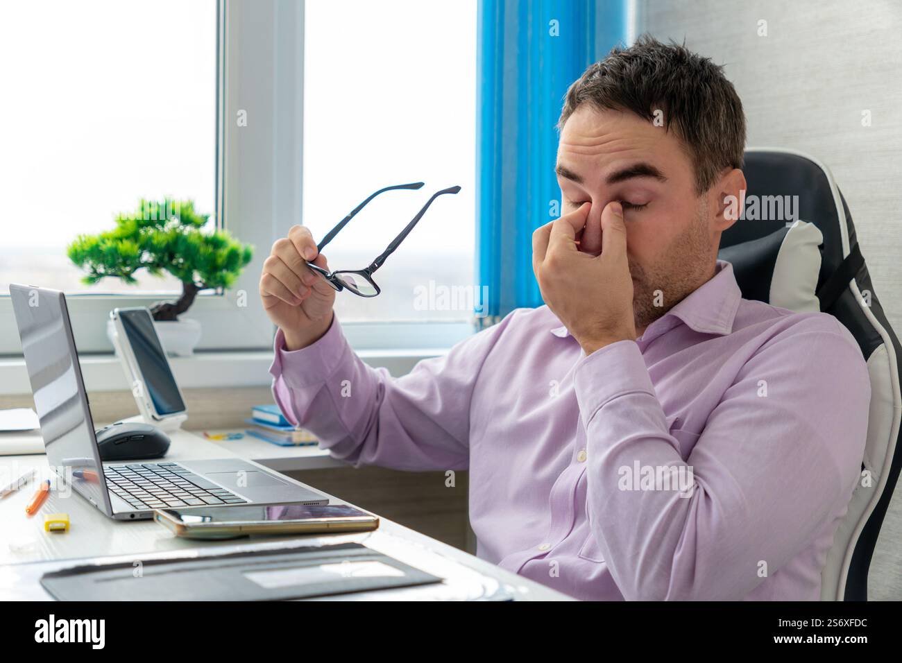 Businessman office working holding sore head pain from desk working and ...