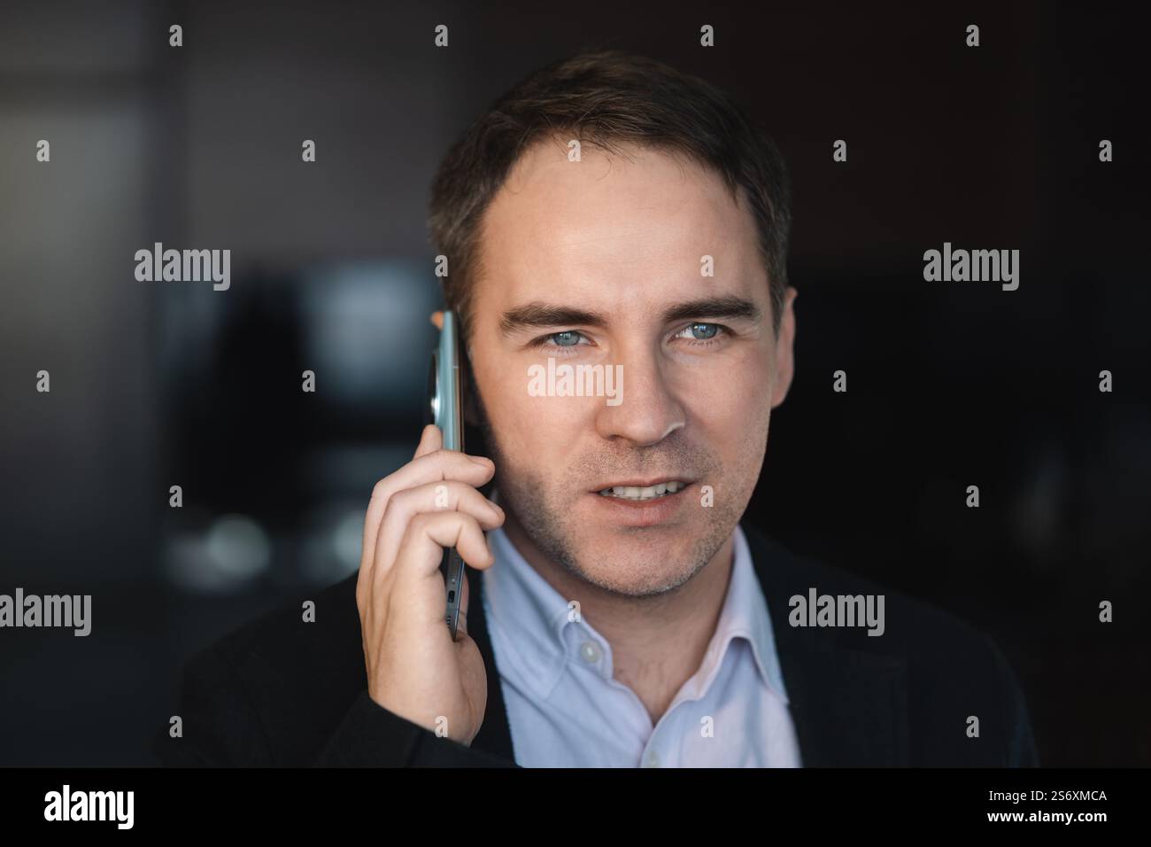 Closeup portrait of smiling young handsome businessman calling on ...