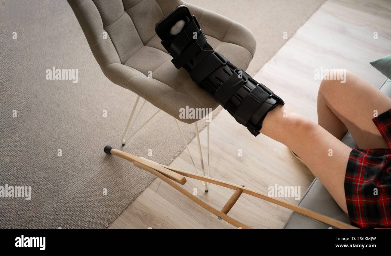 Foot orthosis concept. Close-up of woman leg with ankle orthosis, black ...