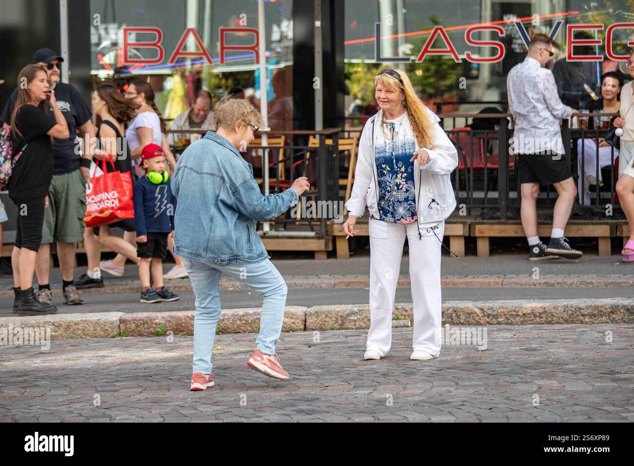 Middle-aged women dancing on Viides linja at Kallio Block Party 2024 in ...