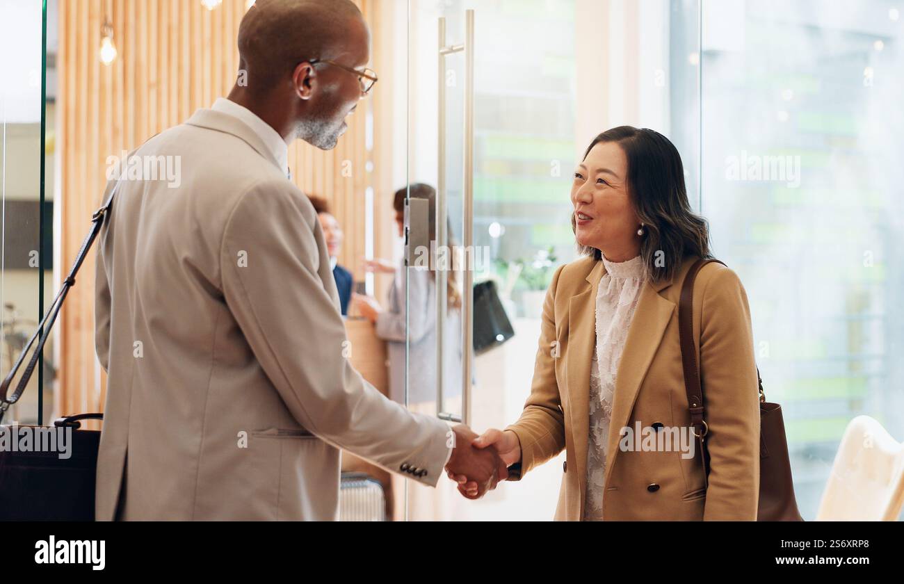 Handshake, introduction and smile with business people in lobby of ...