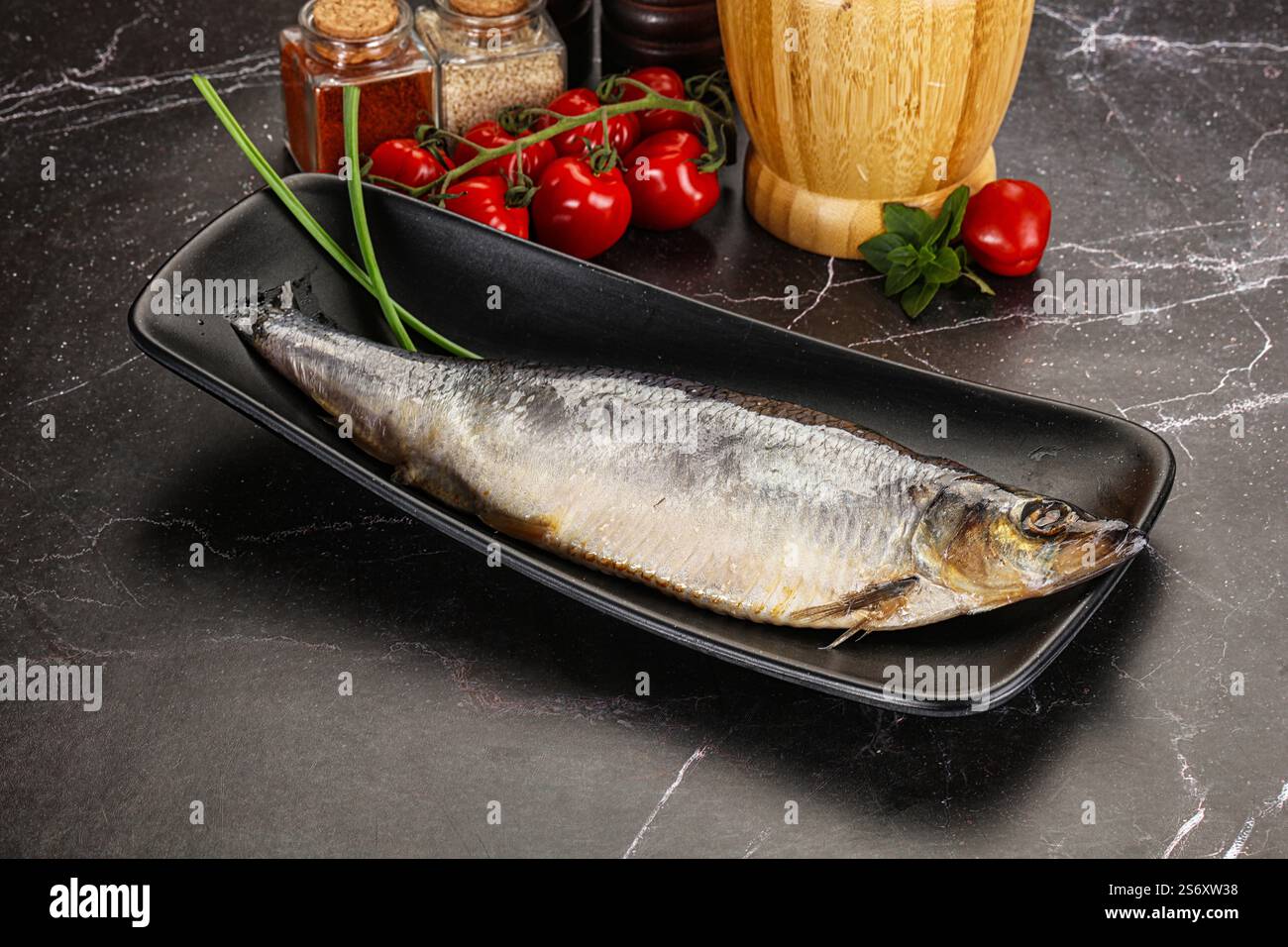 Whole raw salted herring fish in the plate Stock Photo - Alamy