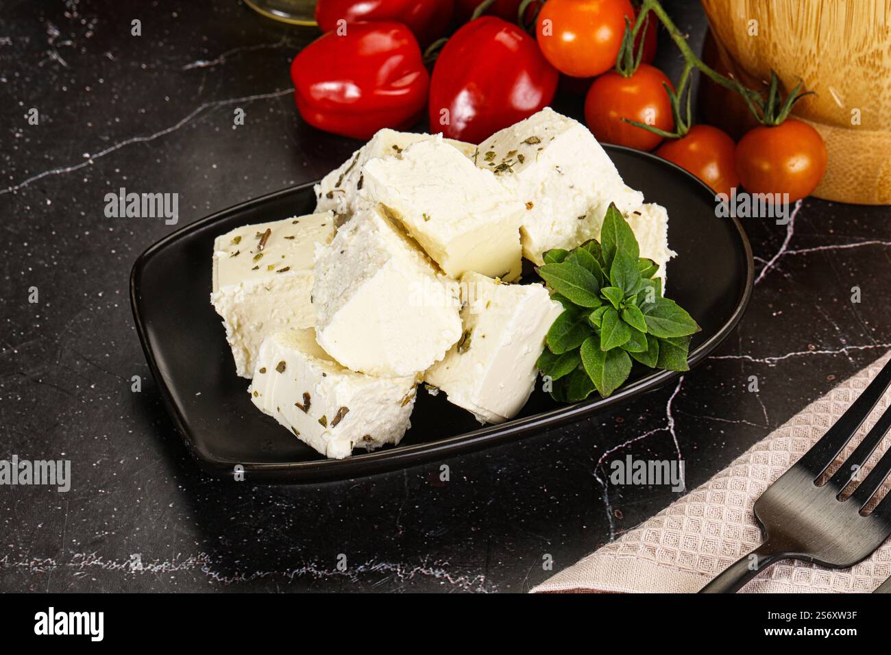 Greek traditional Feta cheese cubes with herbs and spices Stock Photo ...