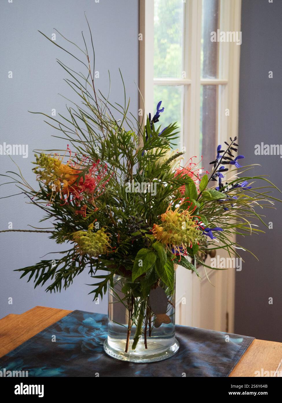 Vase of colourful flowers including Australian native plants on old ...