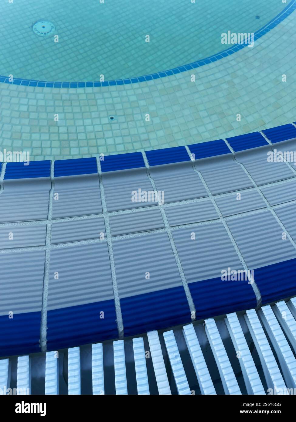 Handrail stairs to the blue pool.Pool with stairs and water. Stainless ...
