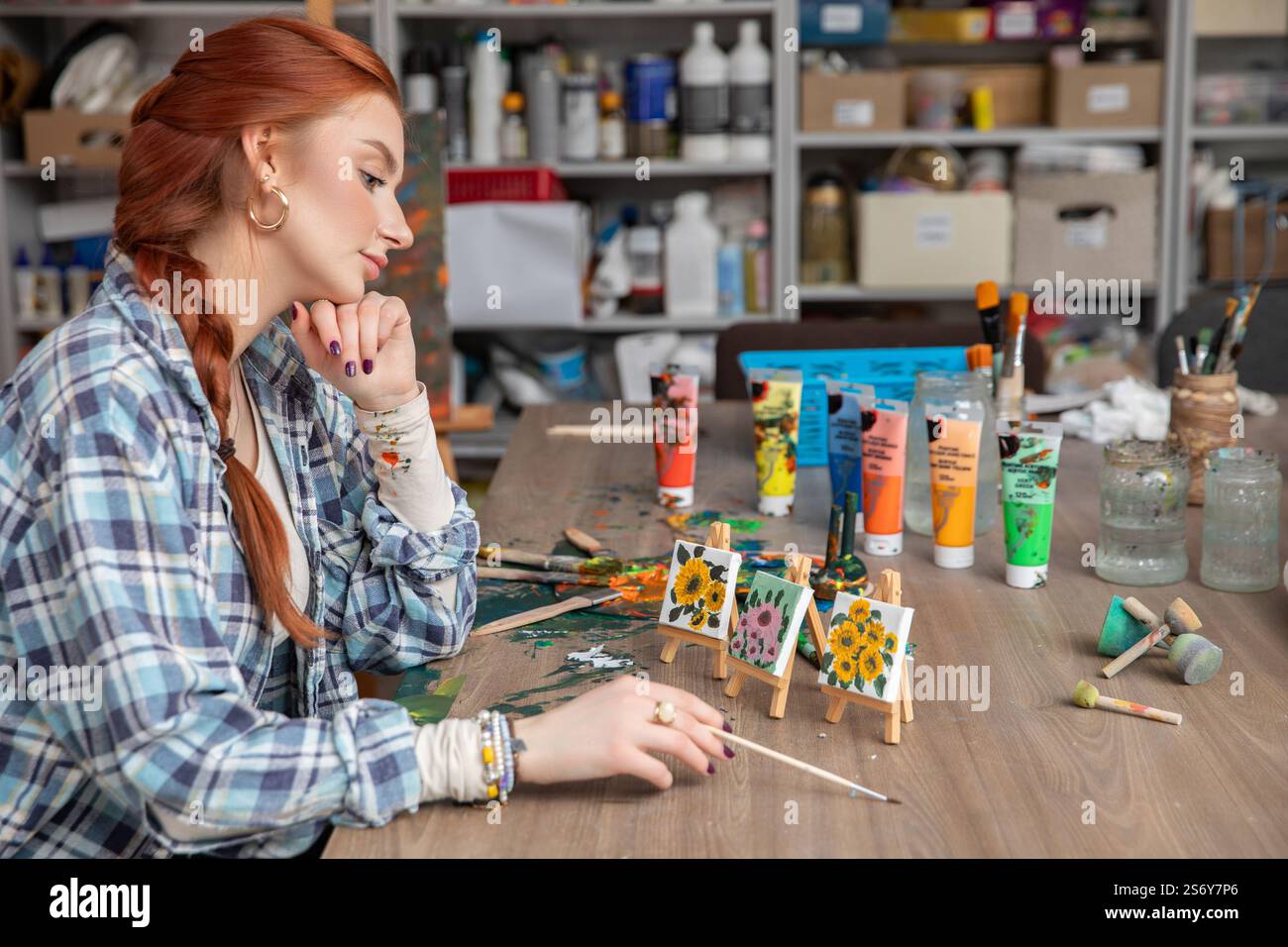 A Creative Artist Engaging in a Studio Environment Surrounded by Paints ...