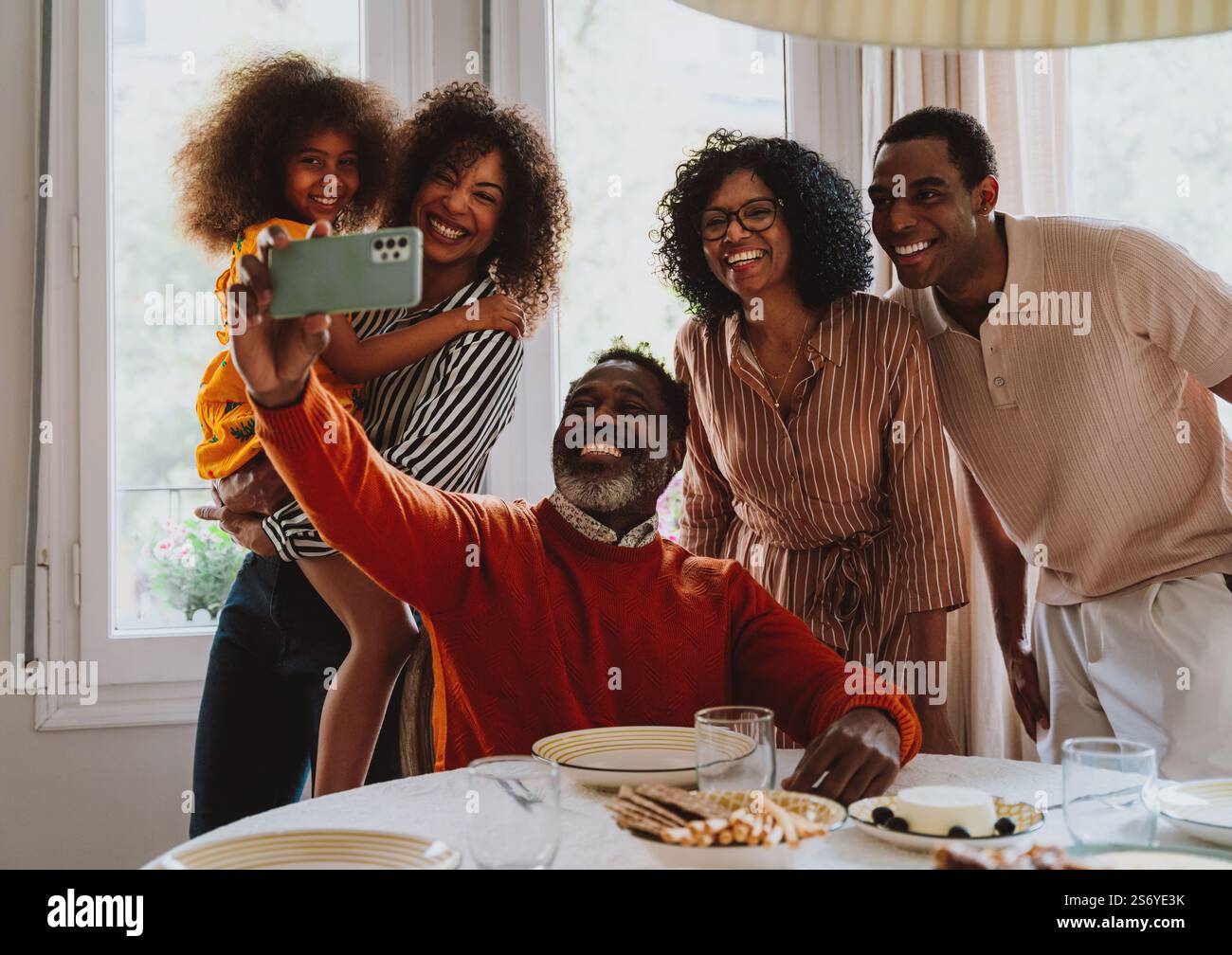 Storytelling image of a Family reunited at parents house for lunch on ...