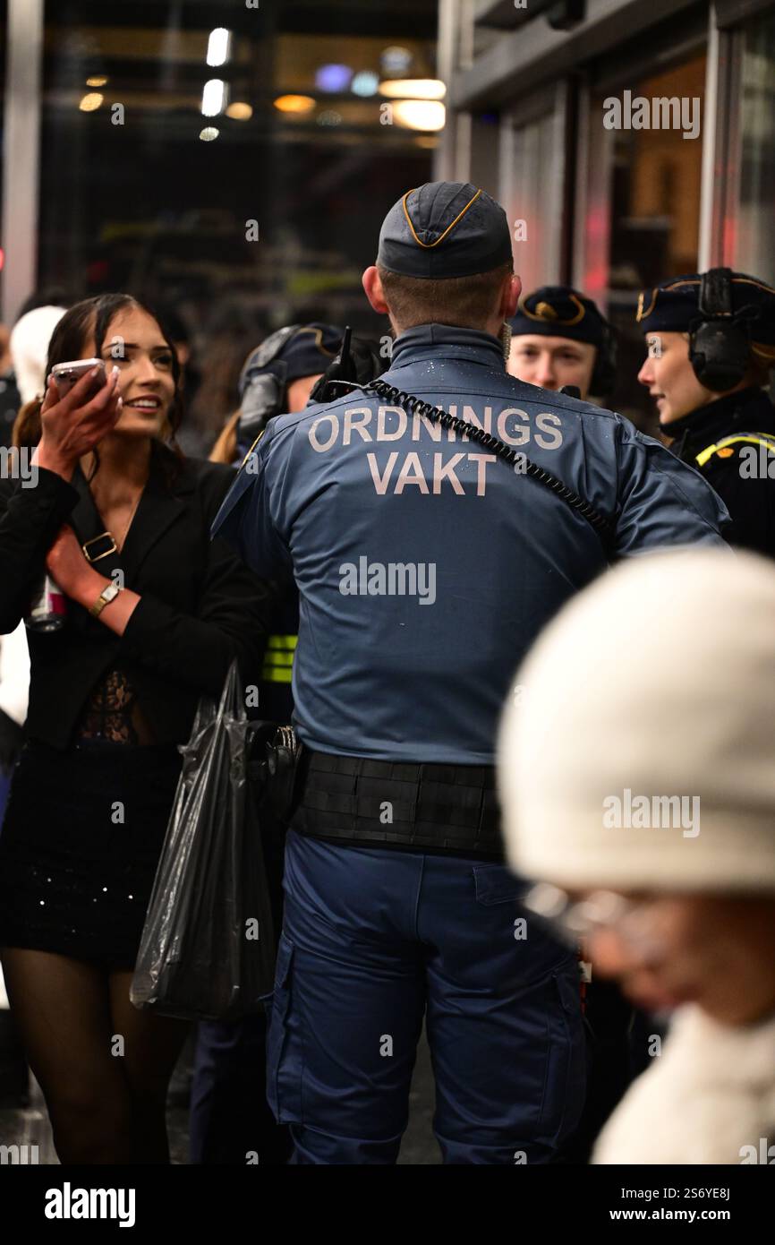 Stockholm, Uppland, Sweden. January 1 2025. Police and security guards ...