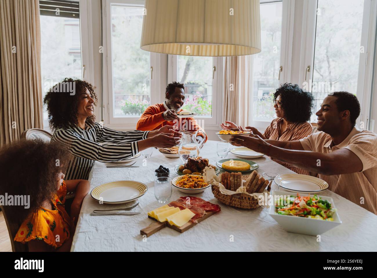 Storytelling image of a Family reunited at parents house for lunch on ...