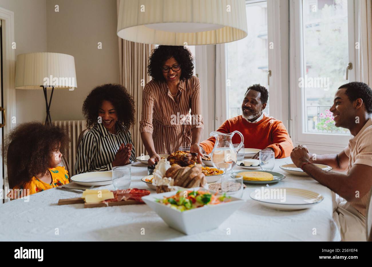 Storytelling image of a Family reunited at parents house for lunch on ...