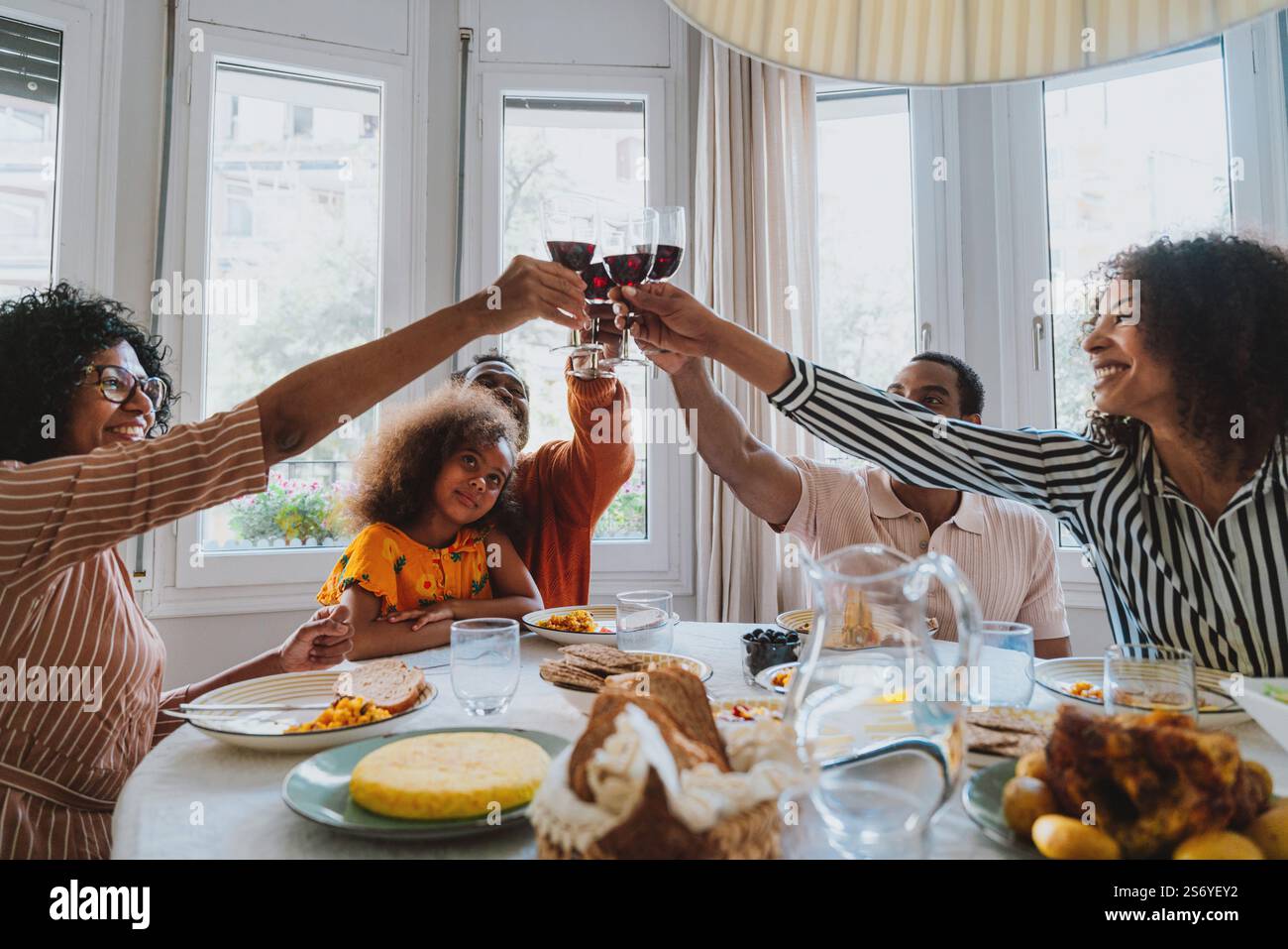 Storytelling image of a Family reunited at parents house for lunch on ...