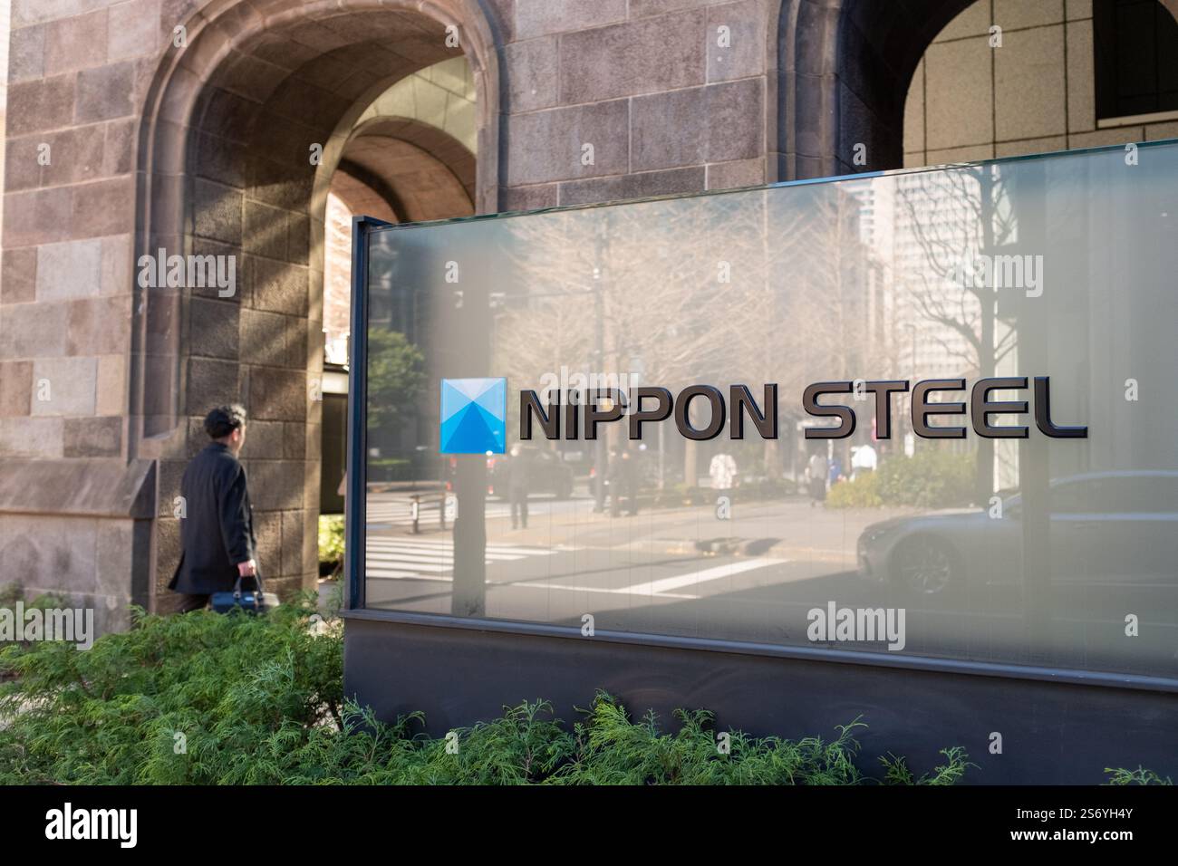 Office workers walk by Nippon Steel headquarters on Friday, Jan. 10 ...